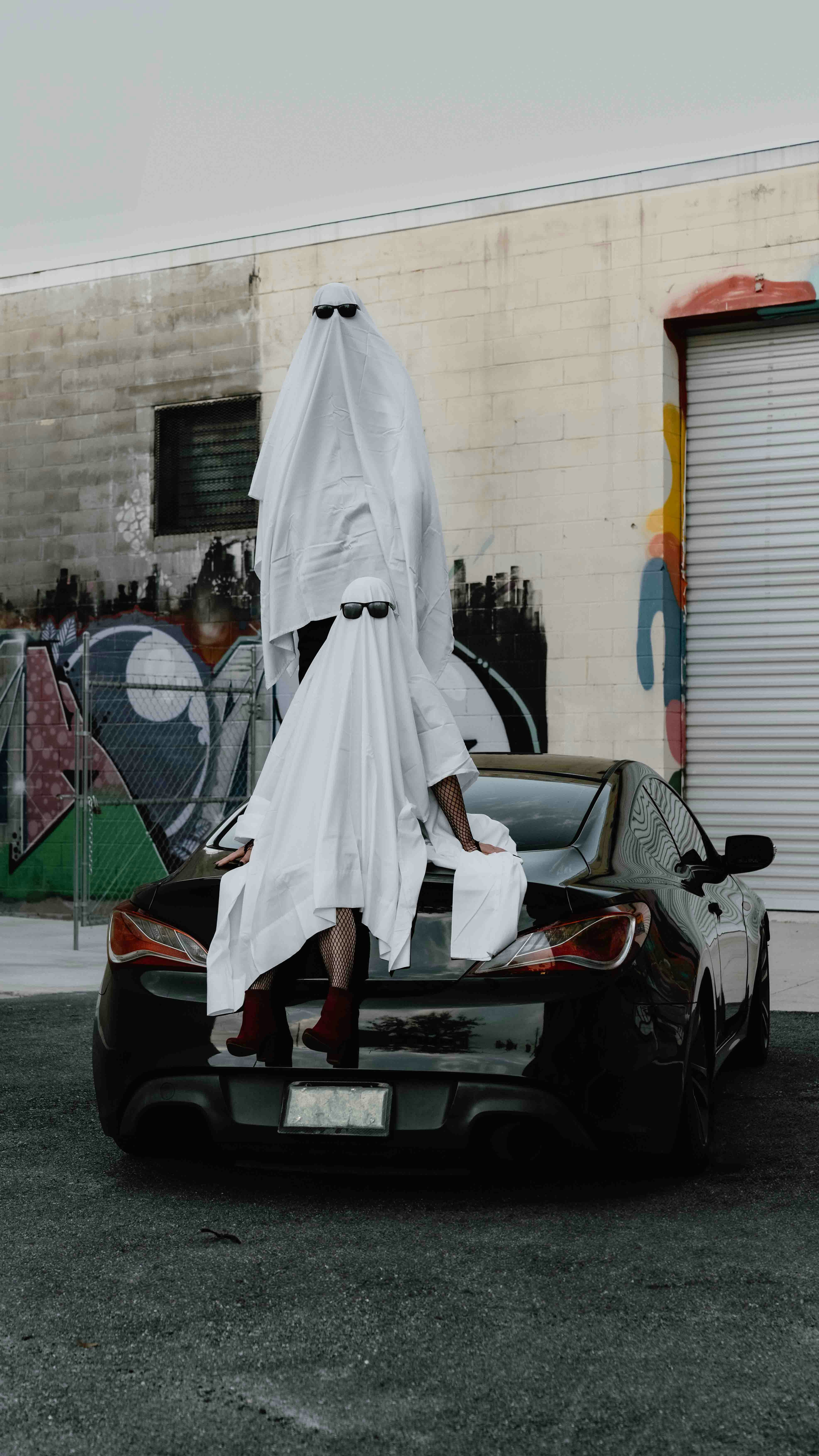 White Shrouds, Black Coupe: Ghostly Duo in the Graffiti Alley