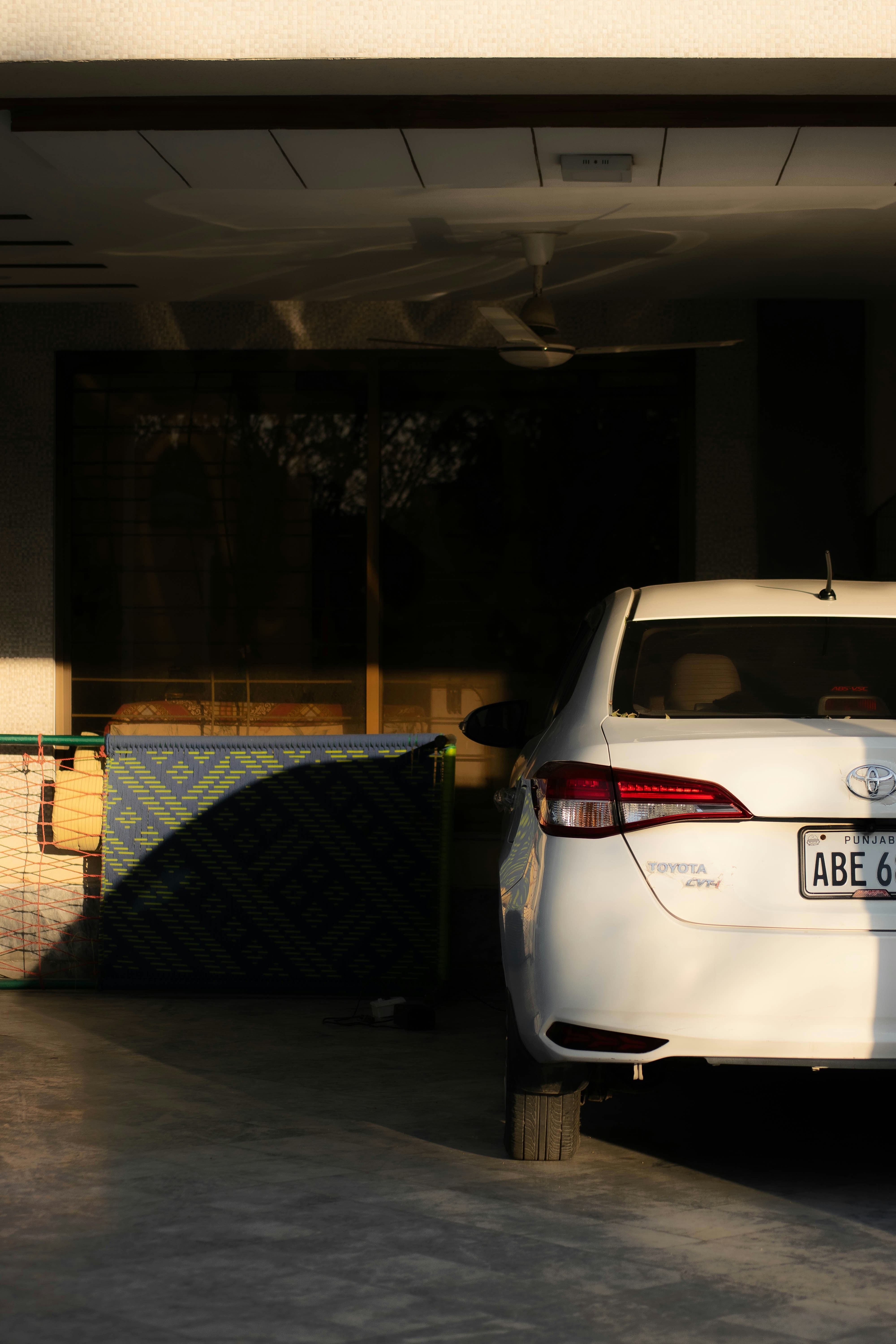 Rear-Right View of a White Toyota in a Dim Garage