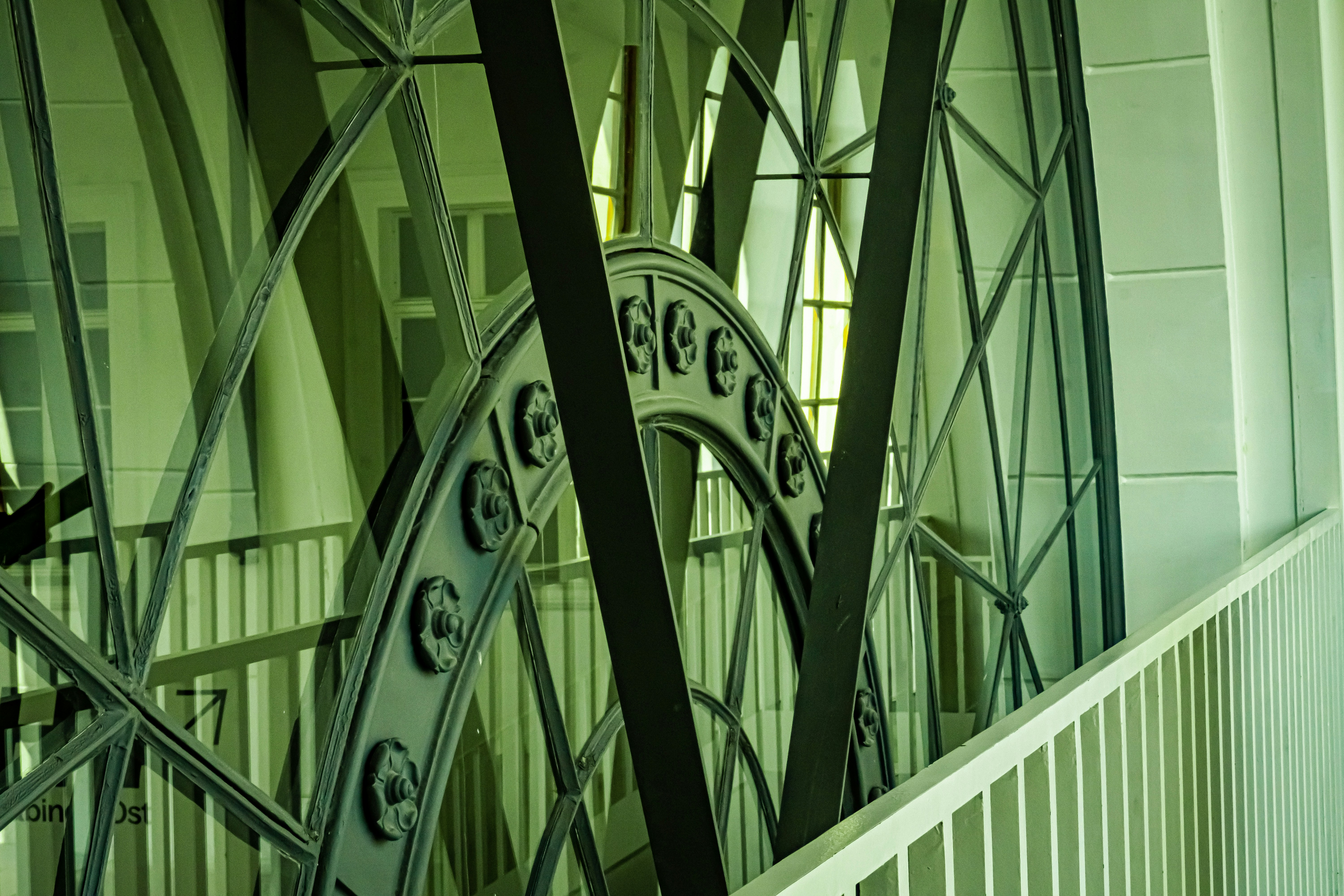 Emerald Wheel Amid Glass and Steel: Geometry of an Industrial Moment