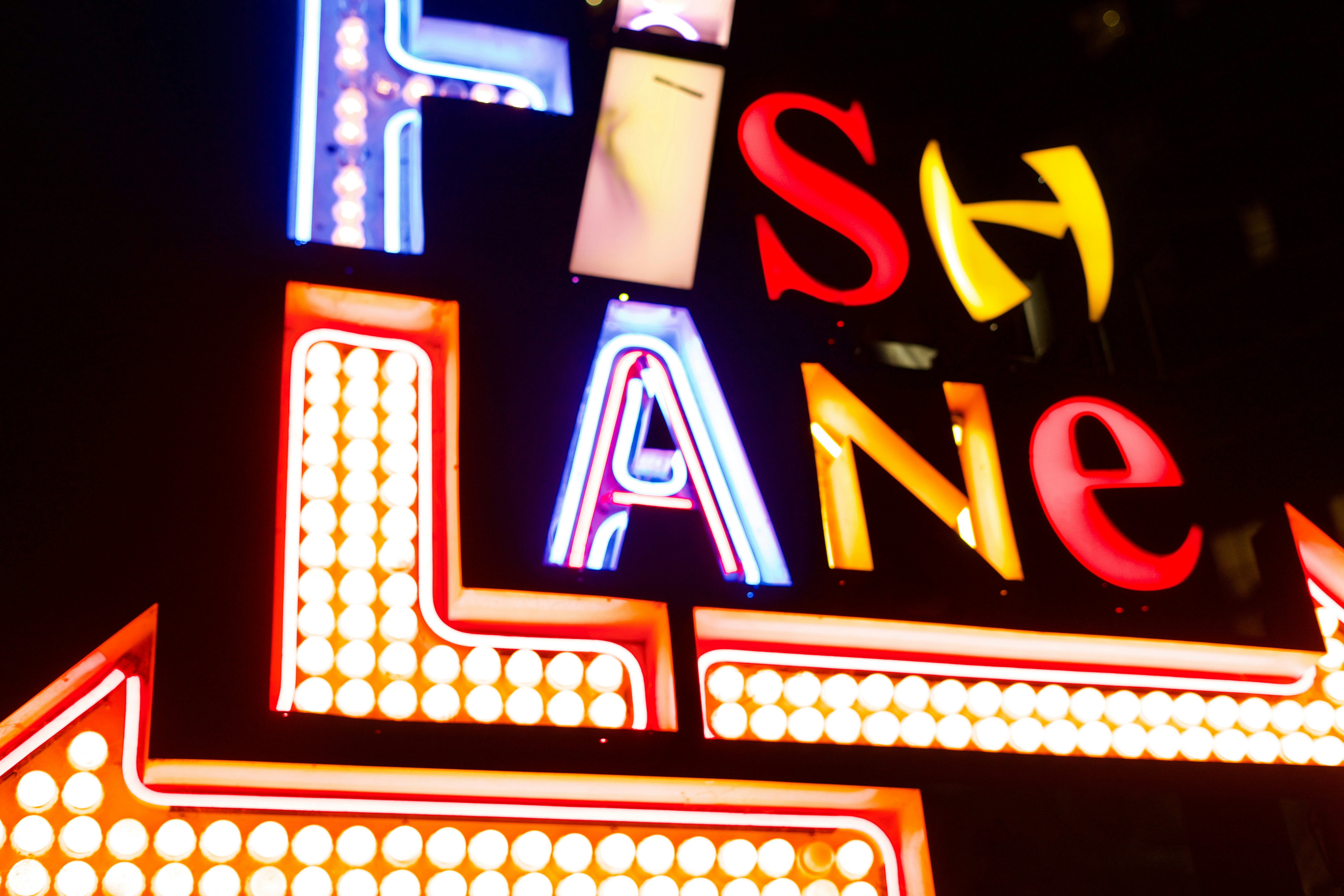 Neon Mosaic: Night Sign Letters in Focus