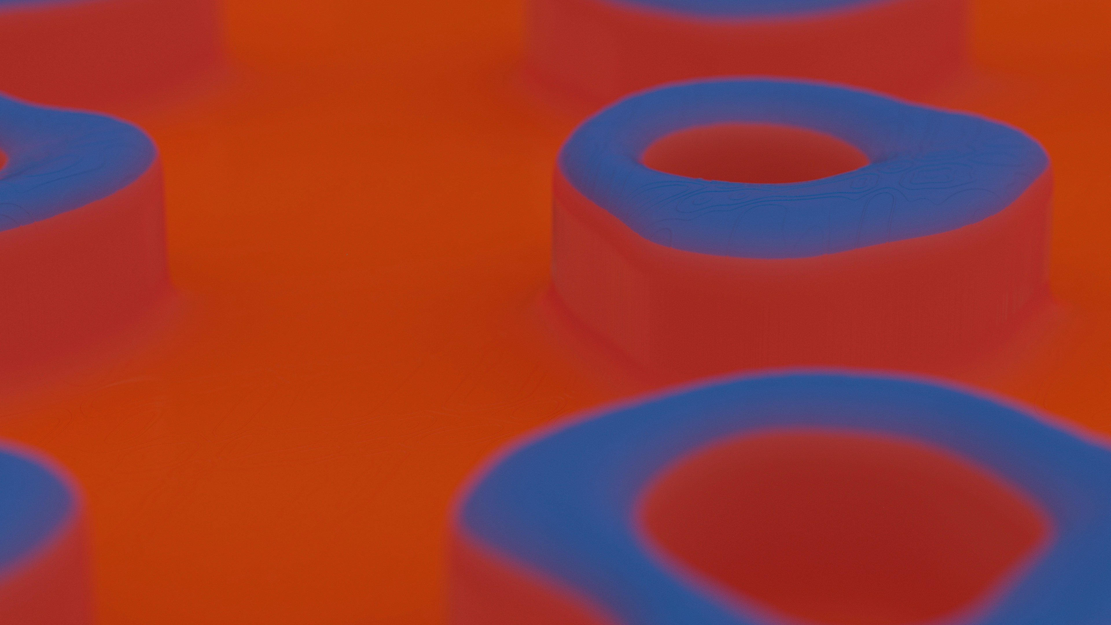 A group of blue and red objects sitting on top of an orange surface ...
