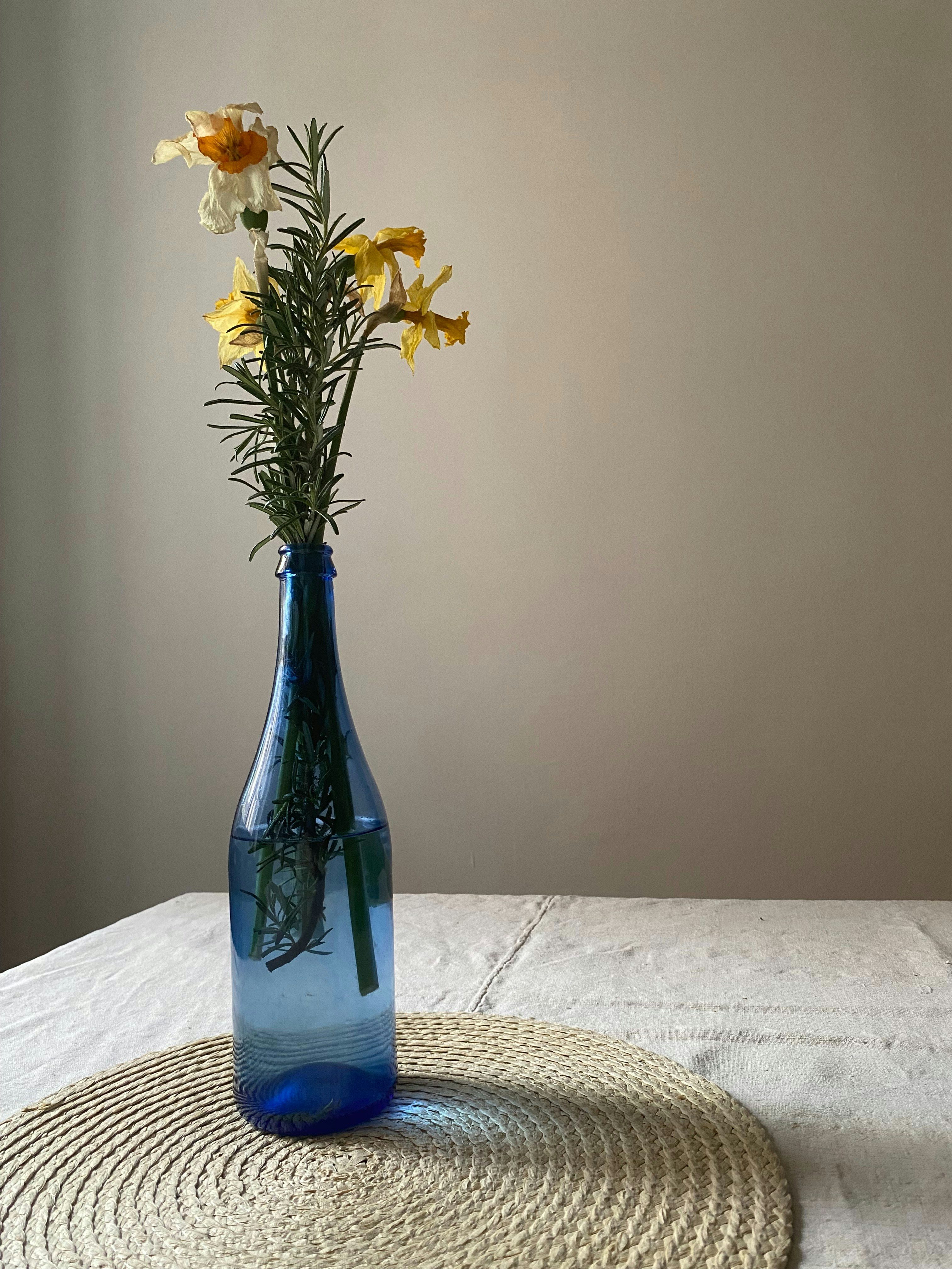 Cobalt Bottle, Daffodils and Rosemary: A Quiet Still-Life on a Linen Table