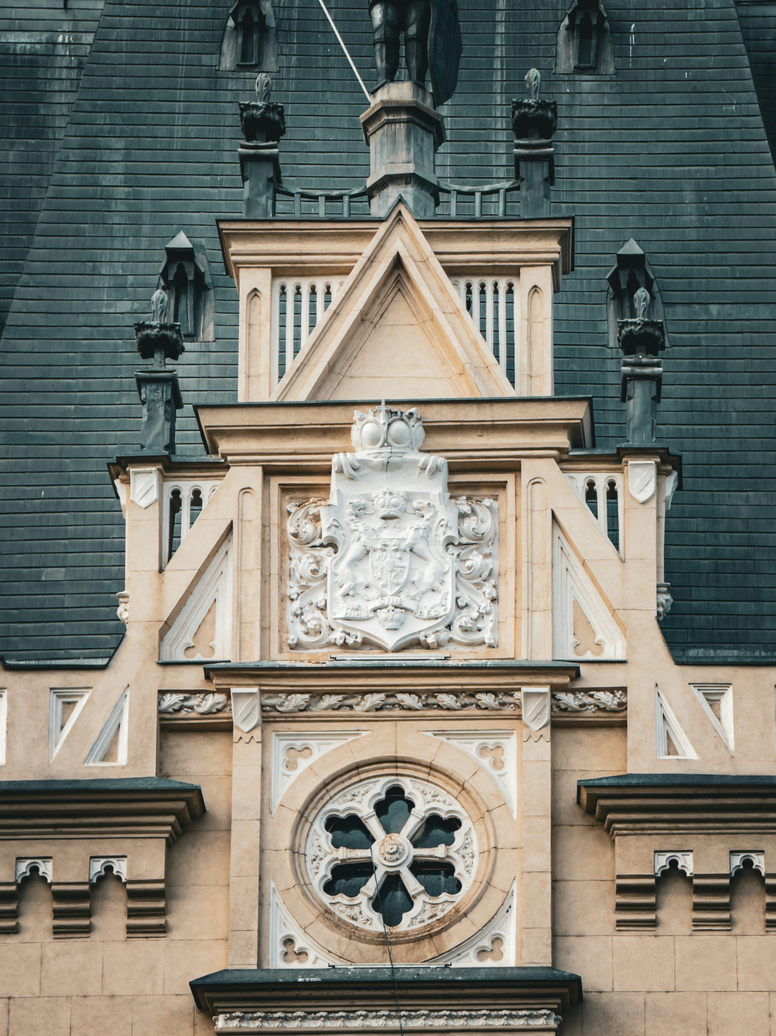 Heraldic Crest Framed by a Stepped Gothic Facade