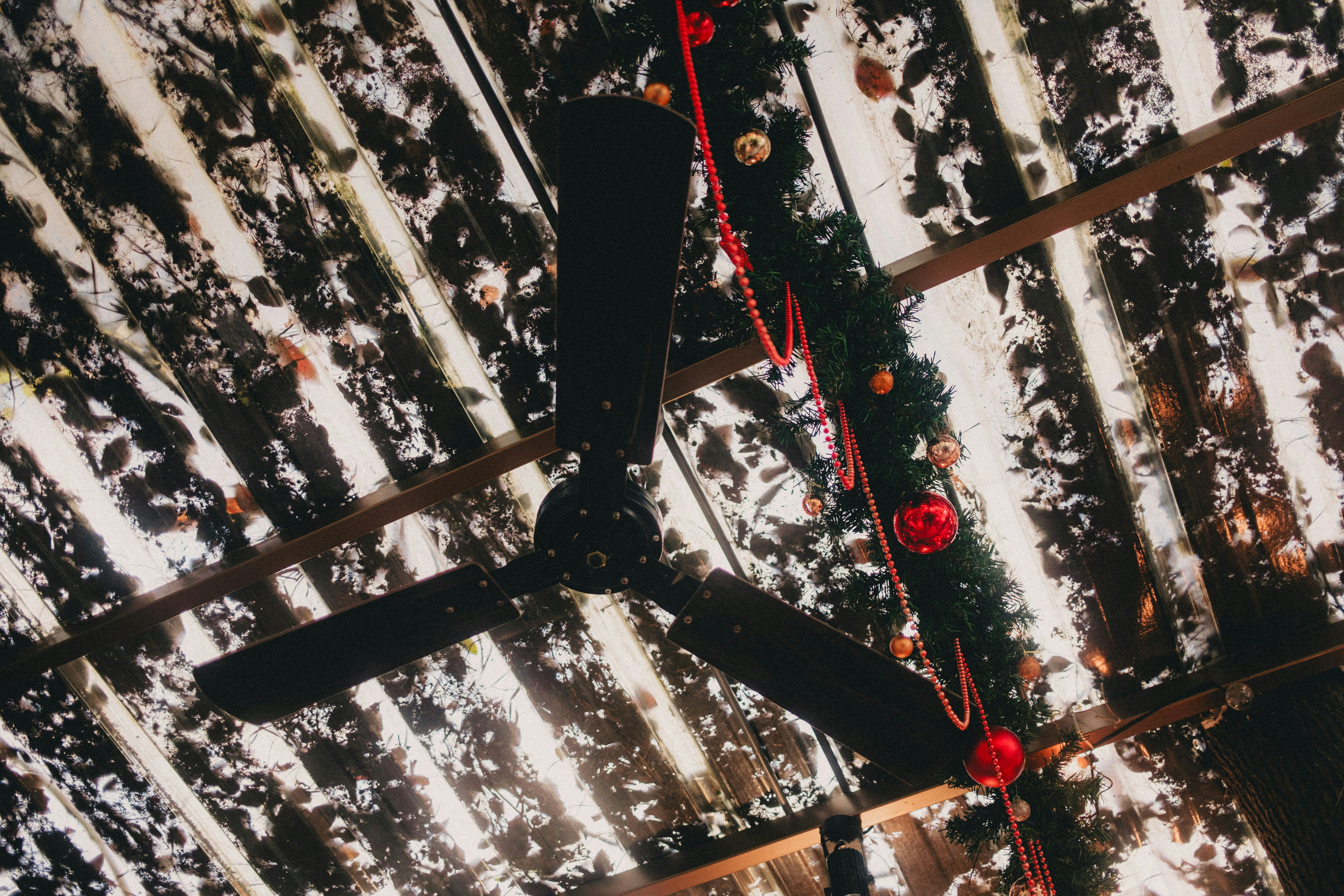 Ceiling Fan Serenade: Festive Garlands Under a Snow-Dusted Ceiling