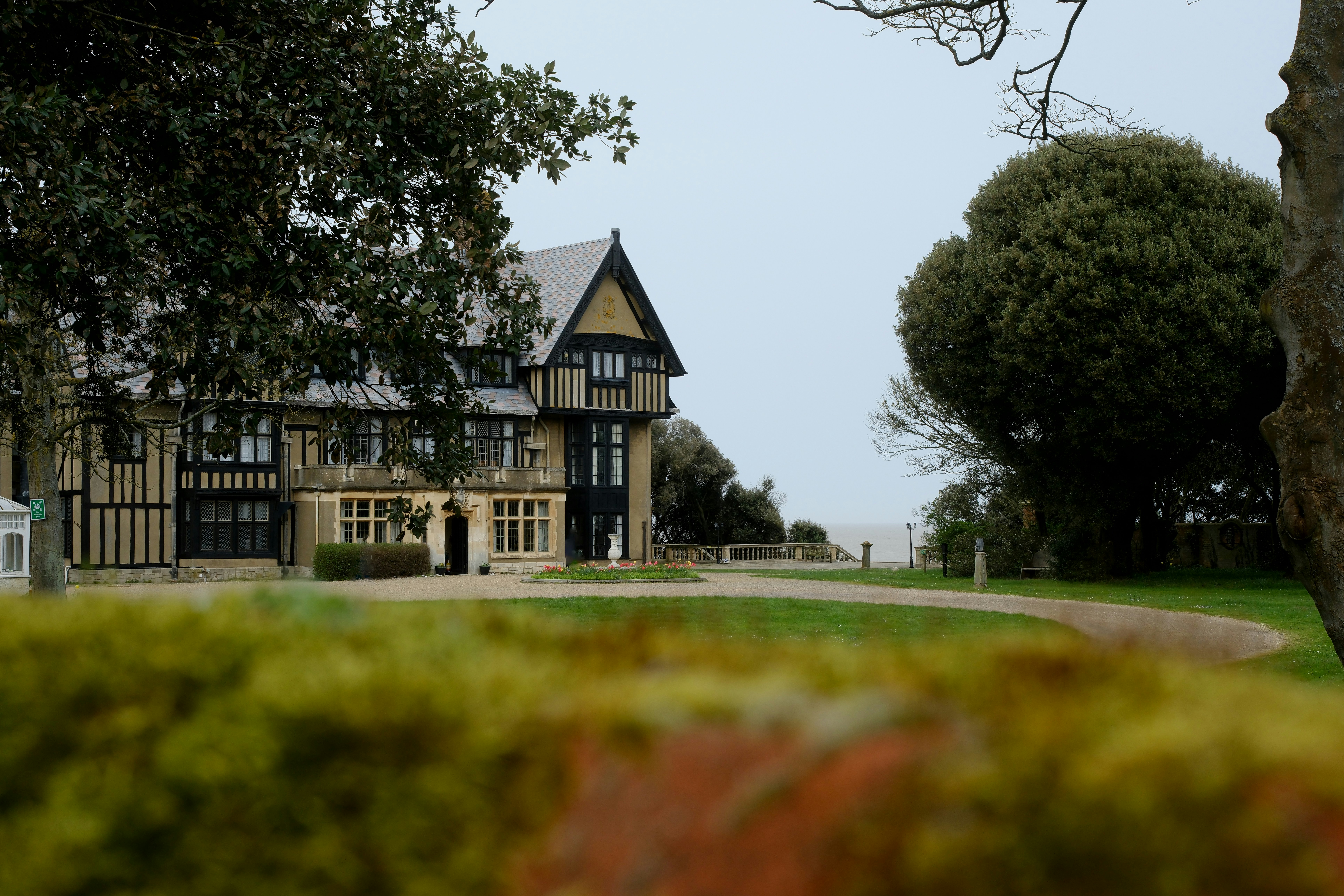 A large house sitting on top of a lush green field photo – Free ...