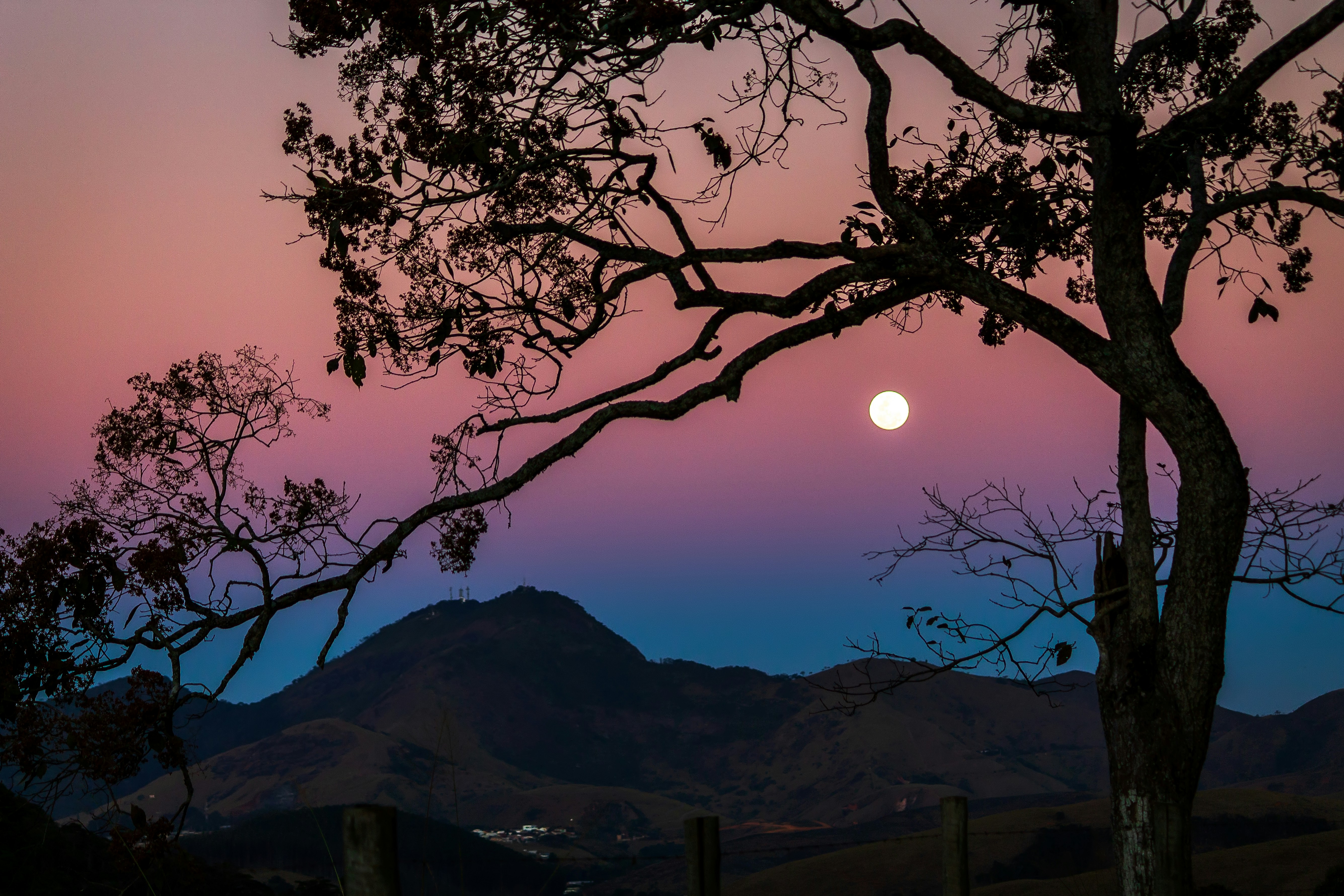The moon is setting over a mountain range photo – Free Moon Image on ...