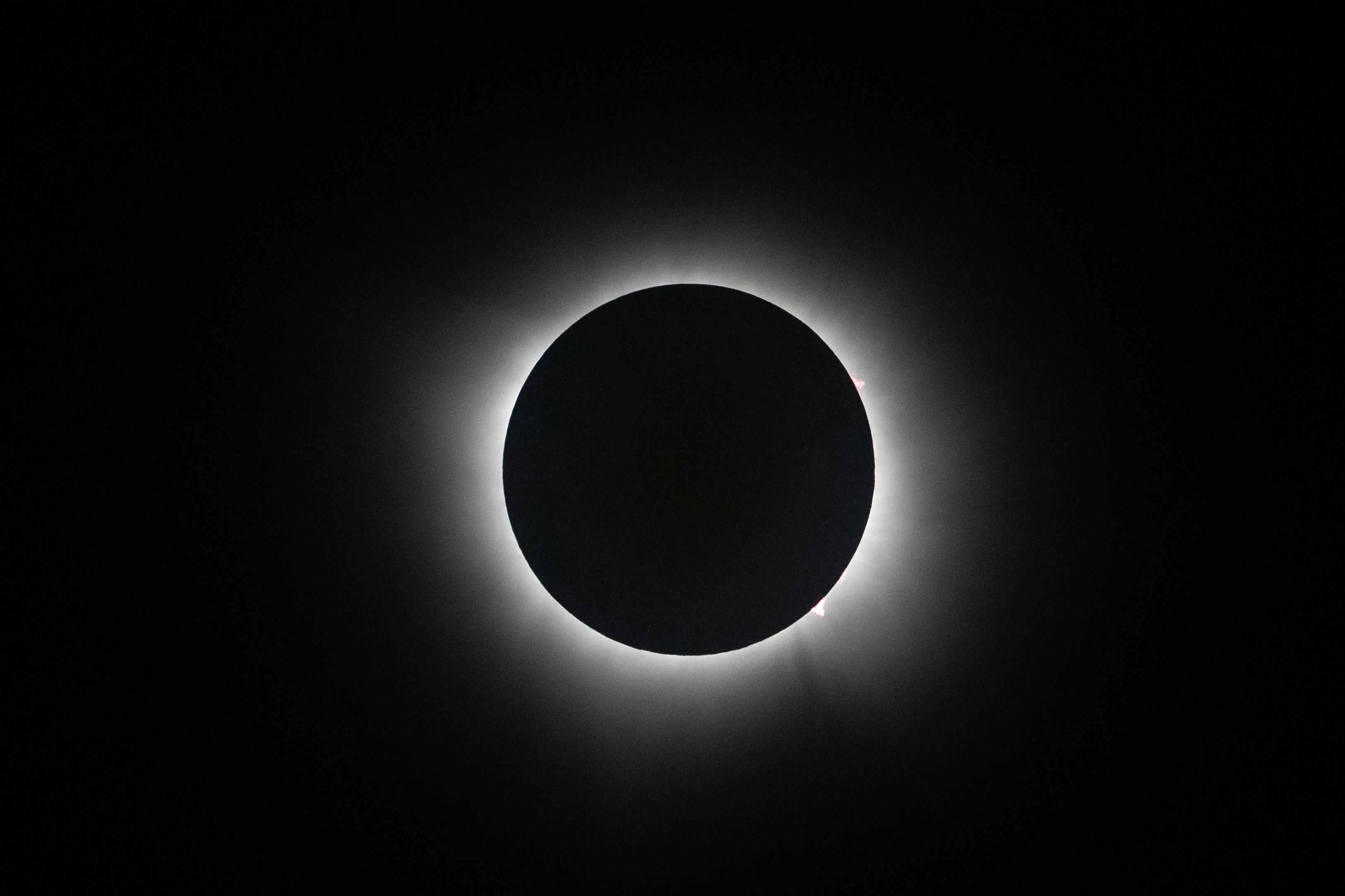 The moon is seen in front of the sun during a solar eclipse photo ...