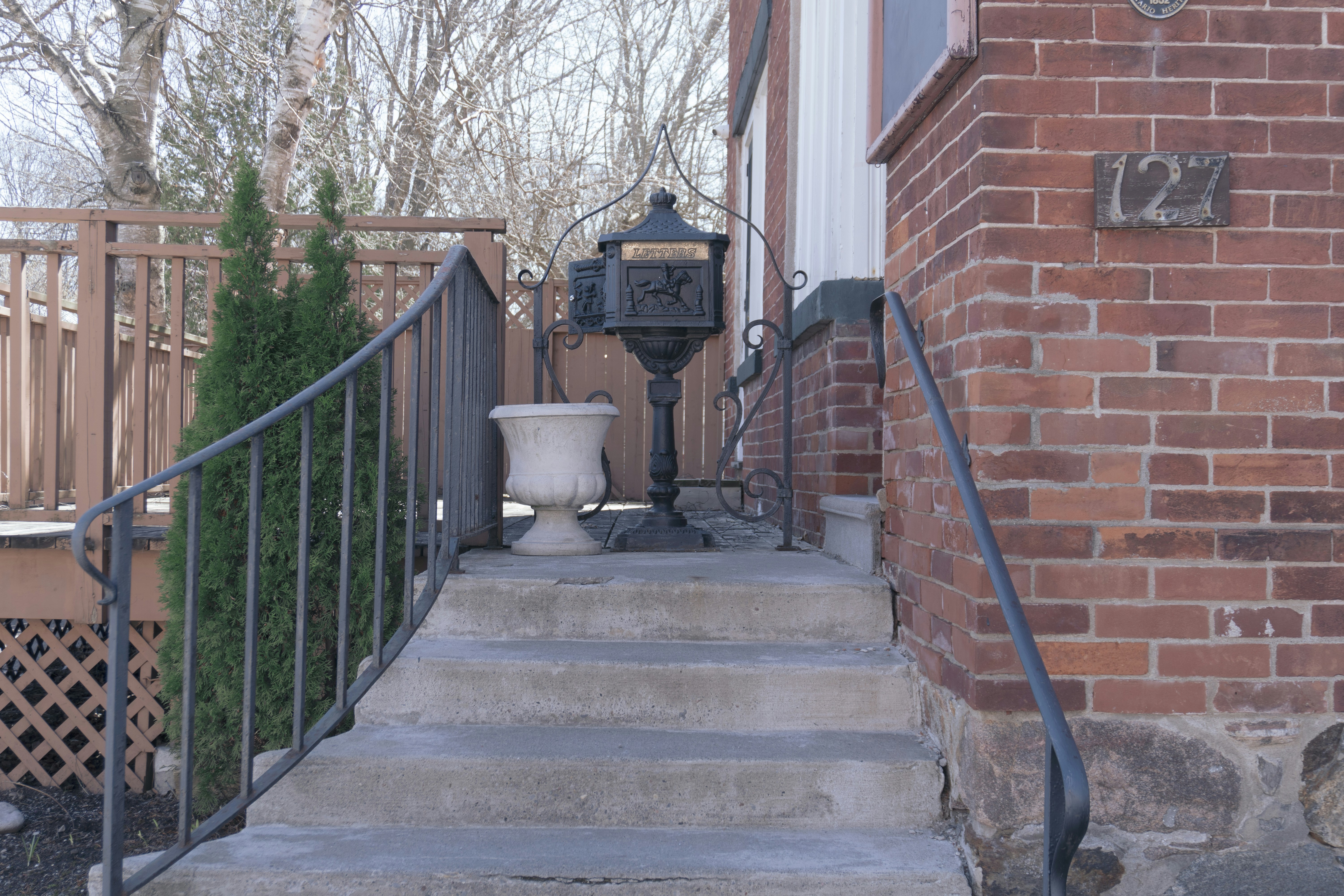 Ornate Lantern Guarding a Brick Stairway to a Quiet Entrance