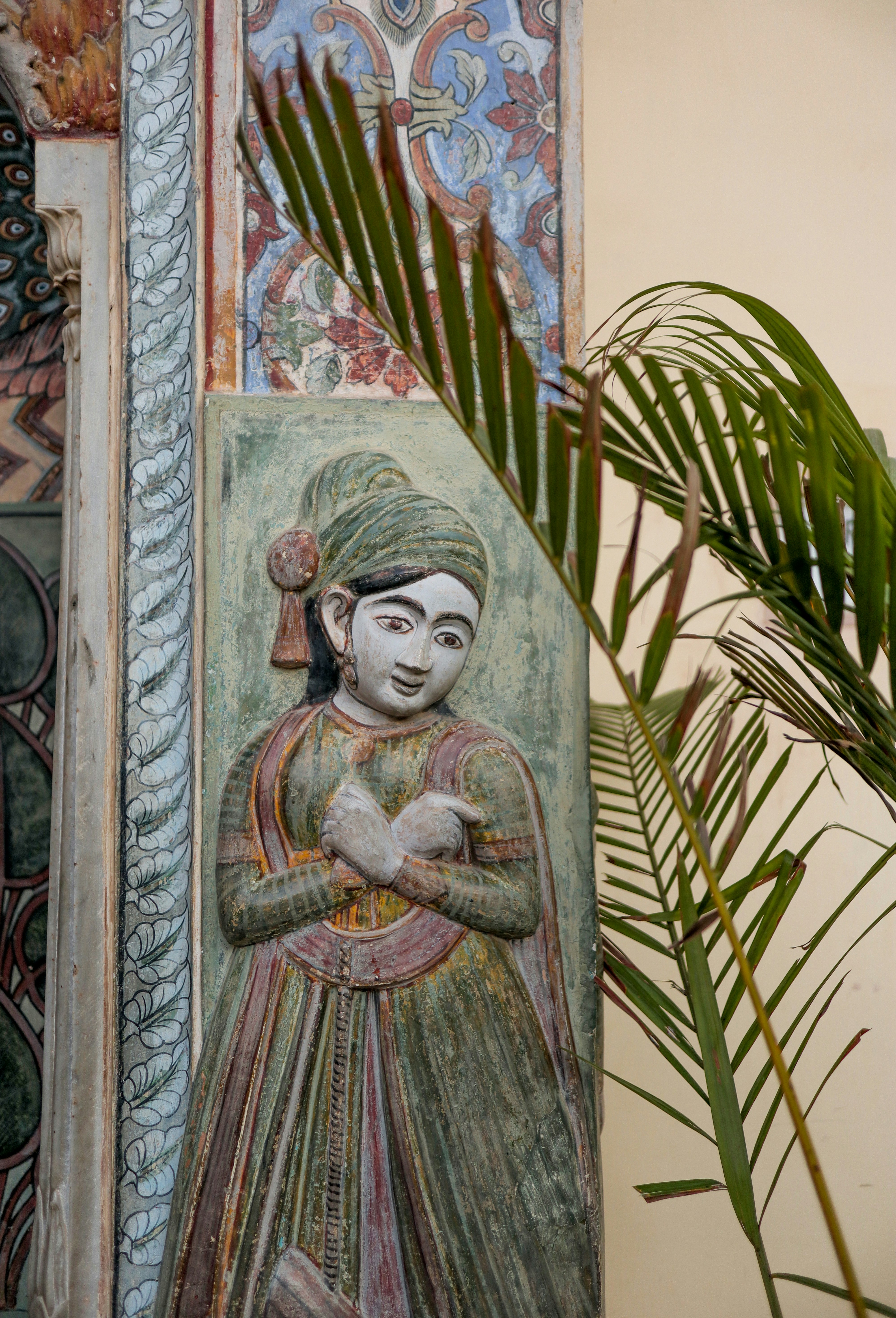 Panel Portrait Amid Ornate Tilework, Framed by Palm Fronds