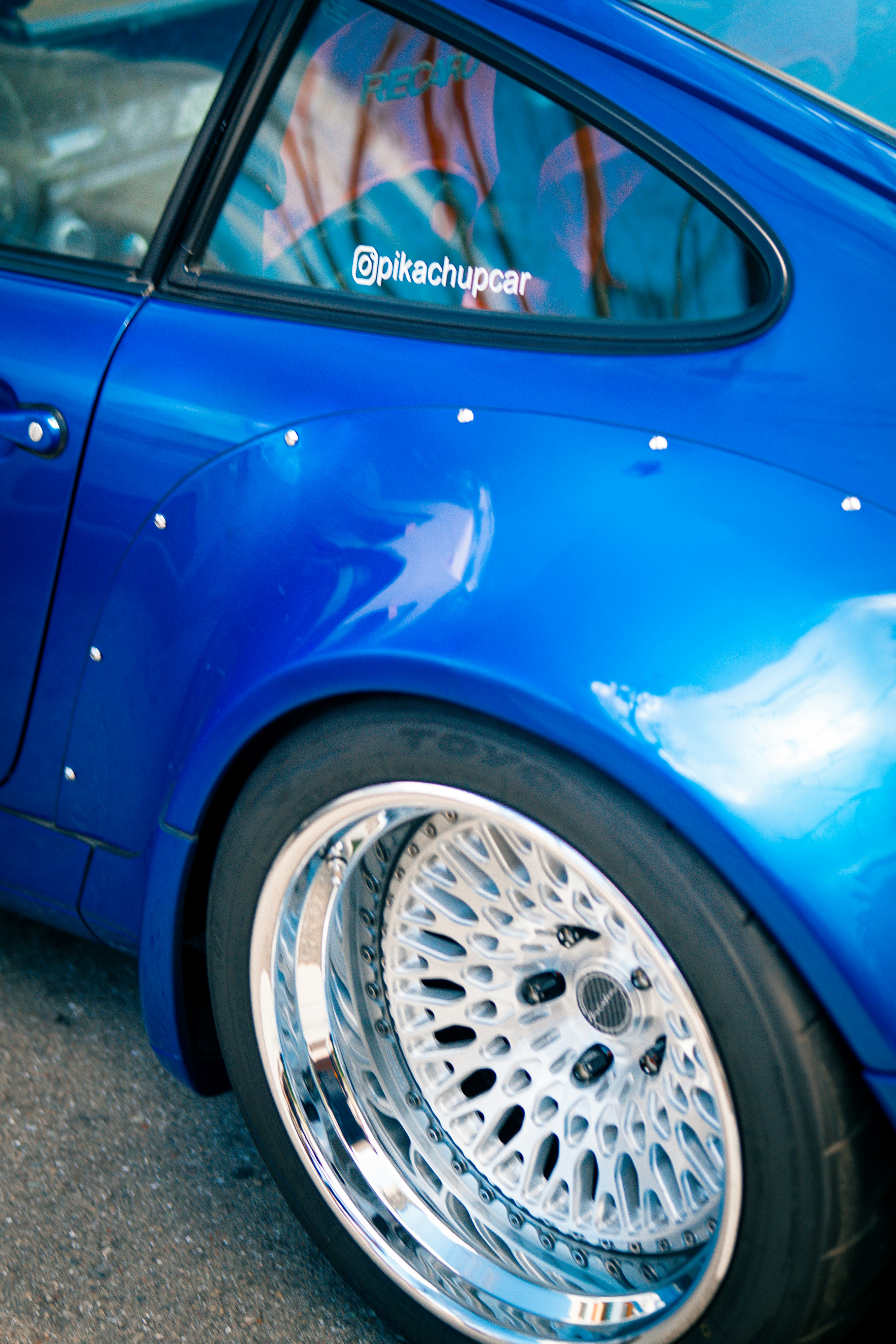 Cobalt Chrome: rivet-lined blue coupe with a lattice-wheel glow