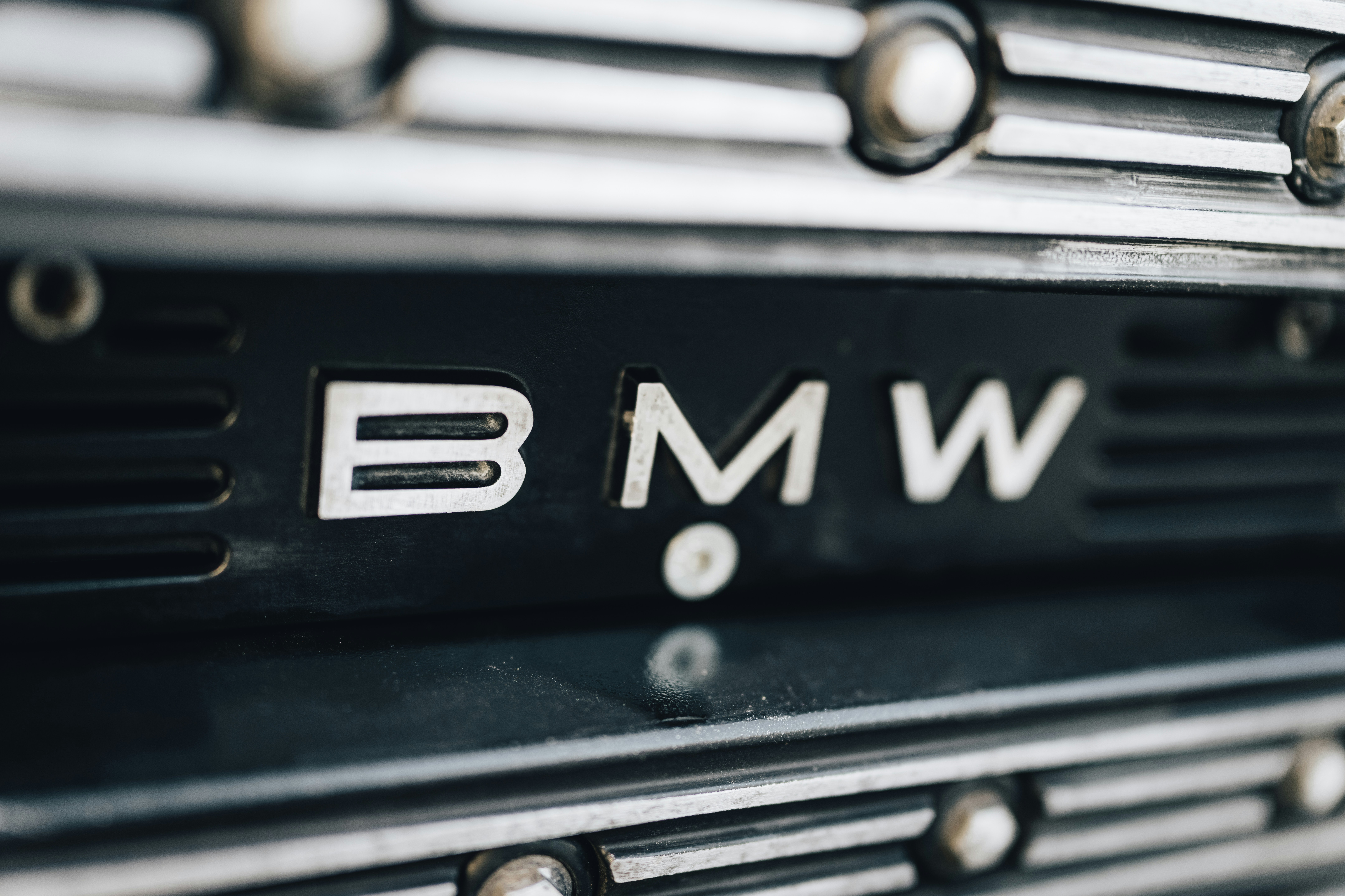 Close-Up Chrome: BMW Badge Framed by a Classic Grille