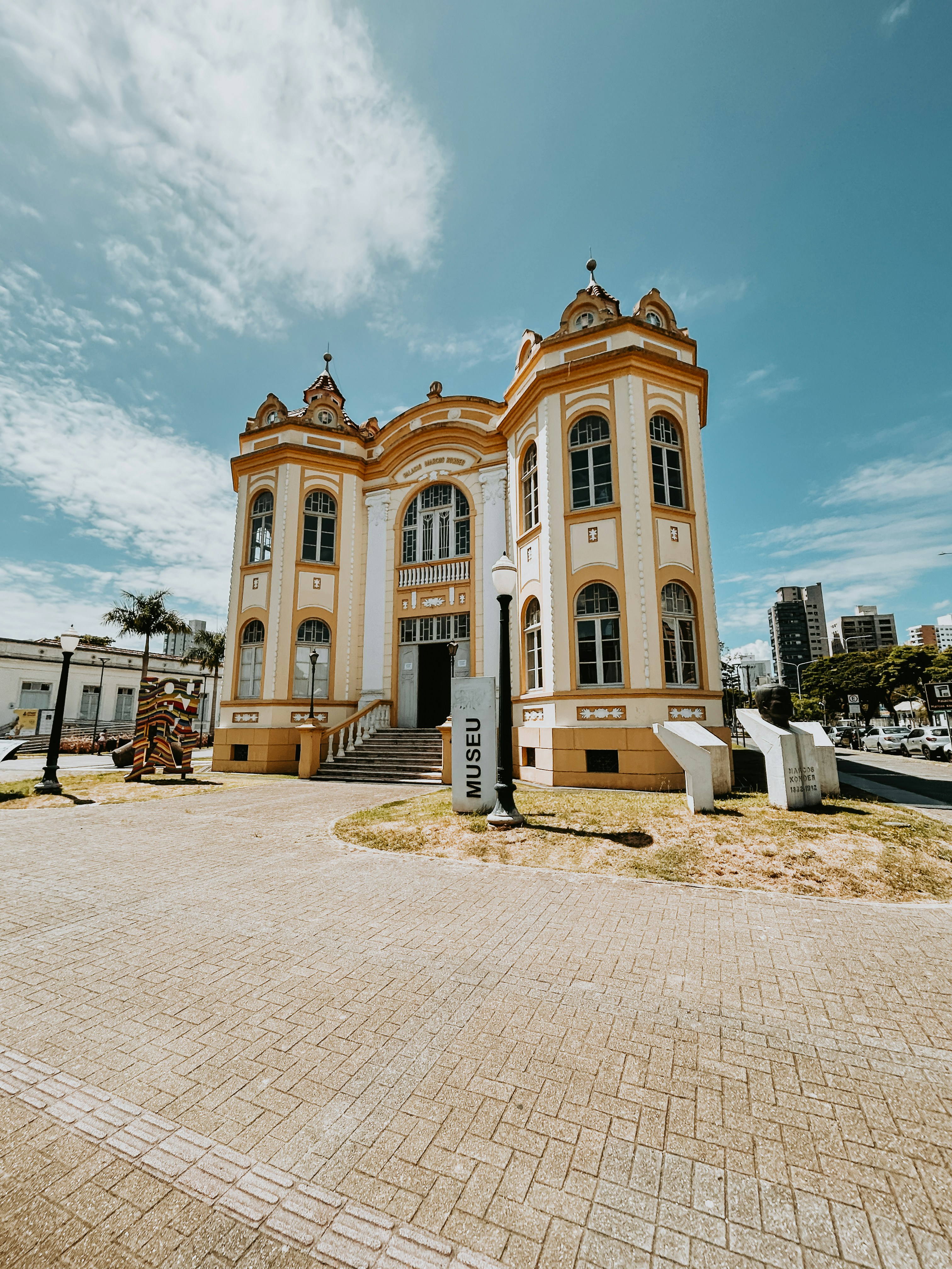 Sunlit Yellow Facade: A Baroque Museum Rising Over the Plaza