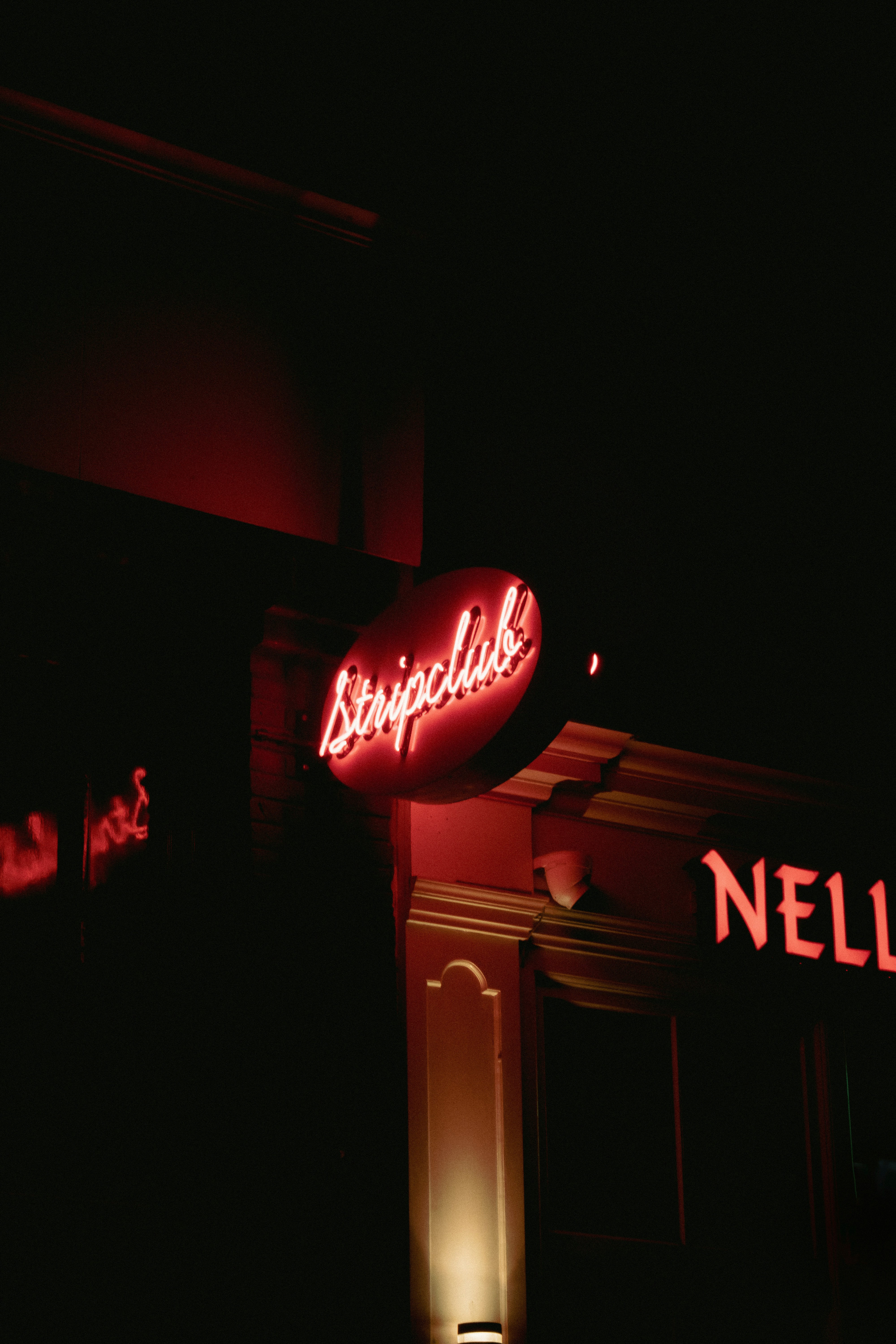 Crimson Neon Circle Illuminates a Dark Street Corner