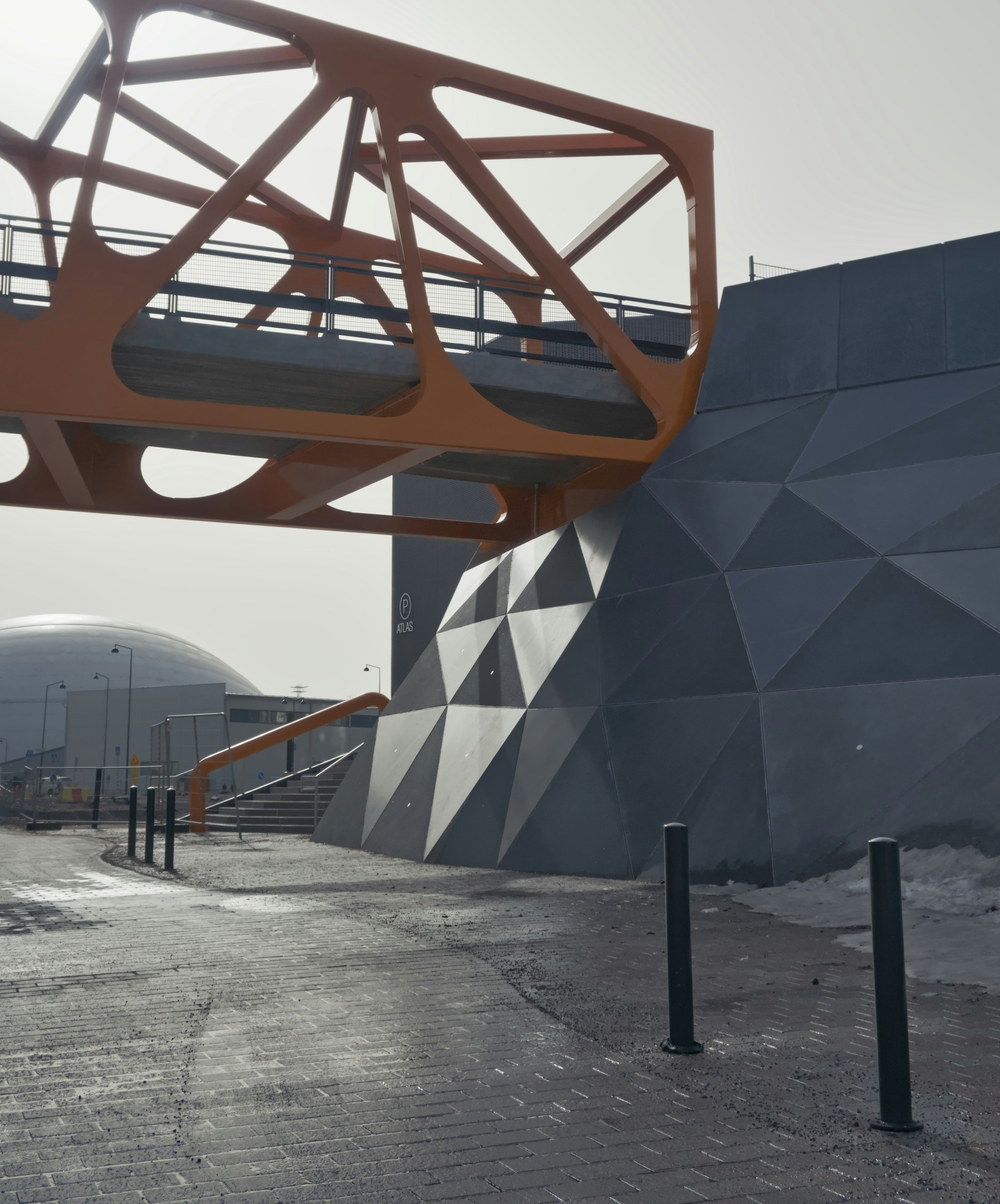 Orange Bridge Over a Geometric Facade at a Modern Dock