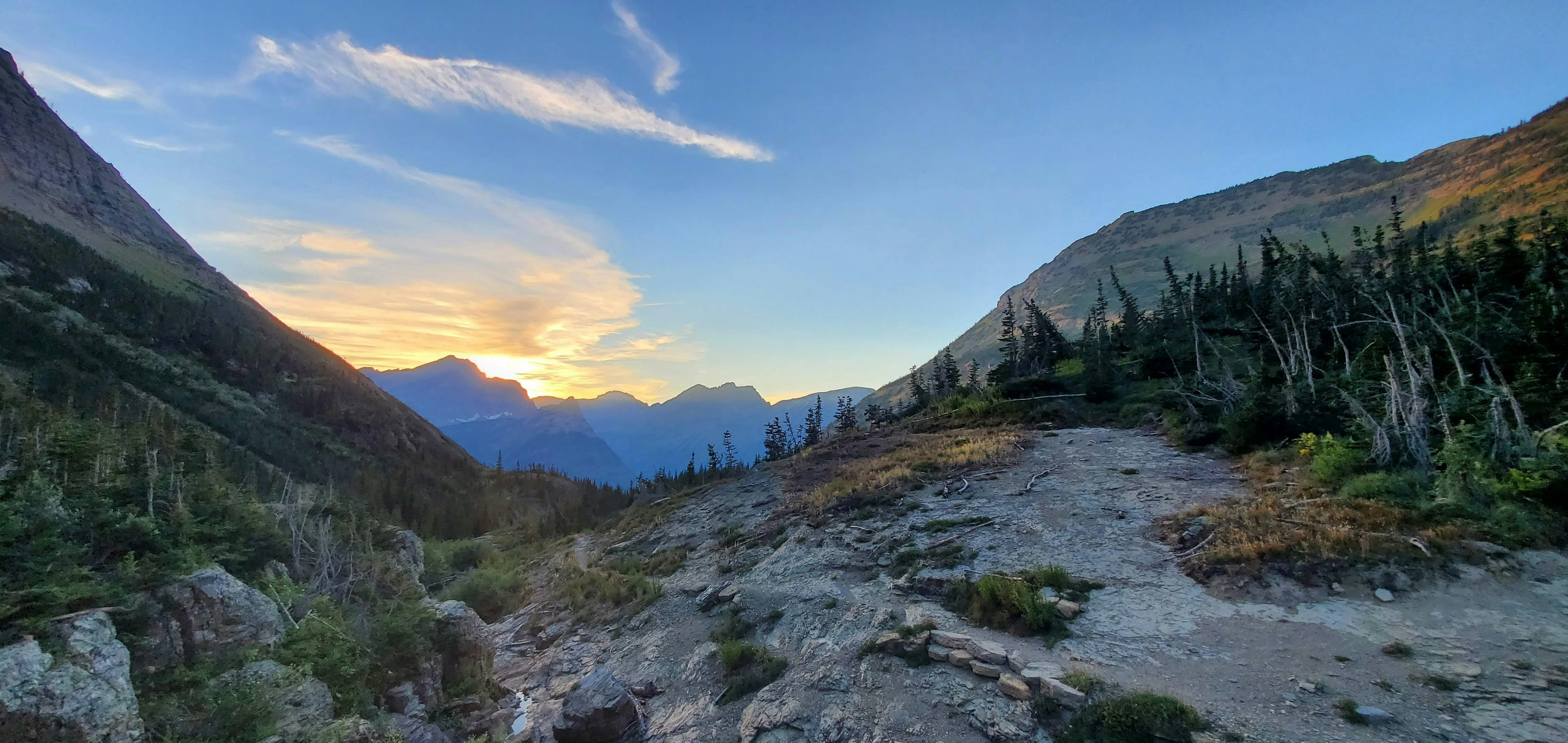 Sunset Over a Rugged Alpine Pass: A Valley Trail Toward Distant Blues