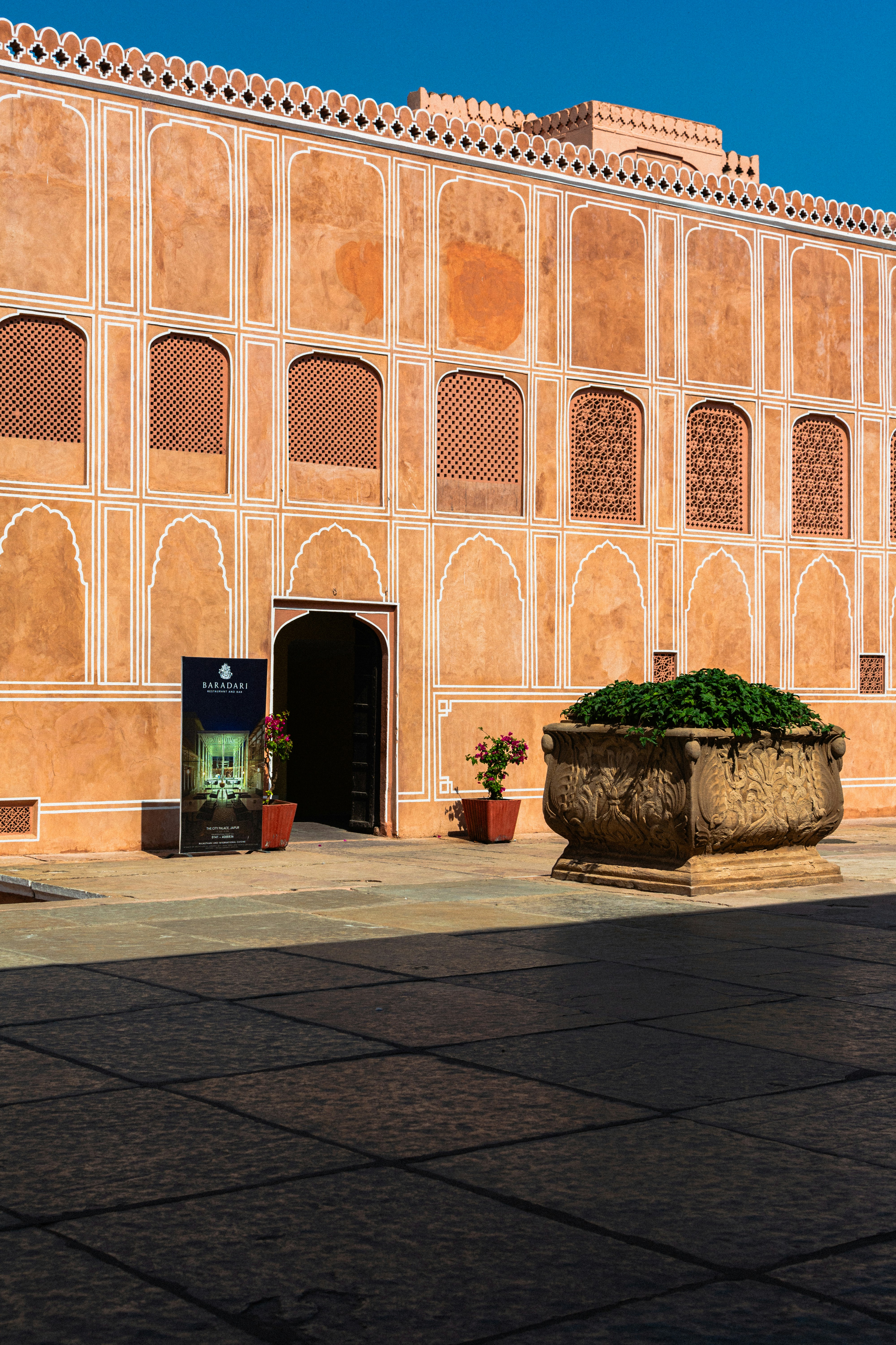 Sunlit Facade of a Moorish Courtyard with Central Planter
