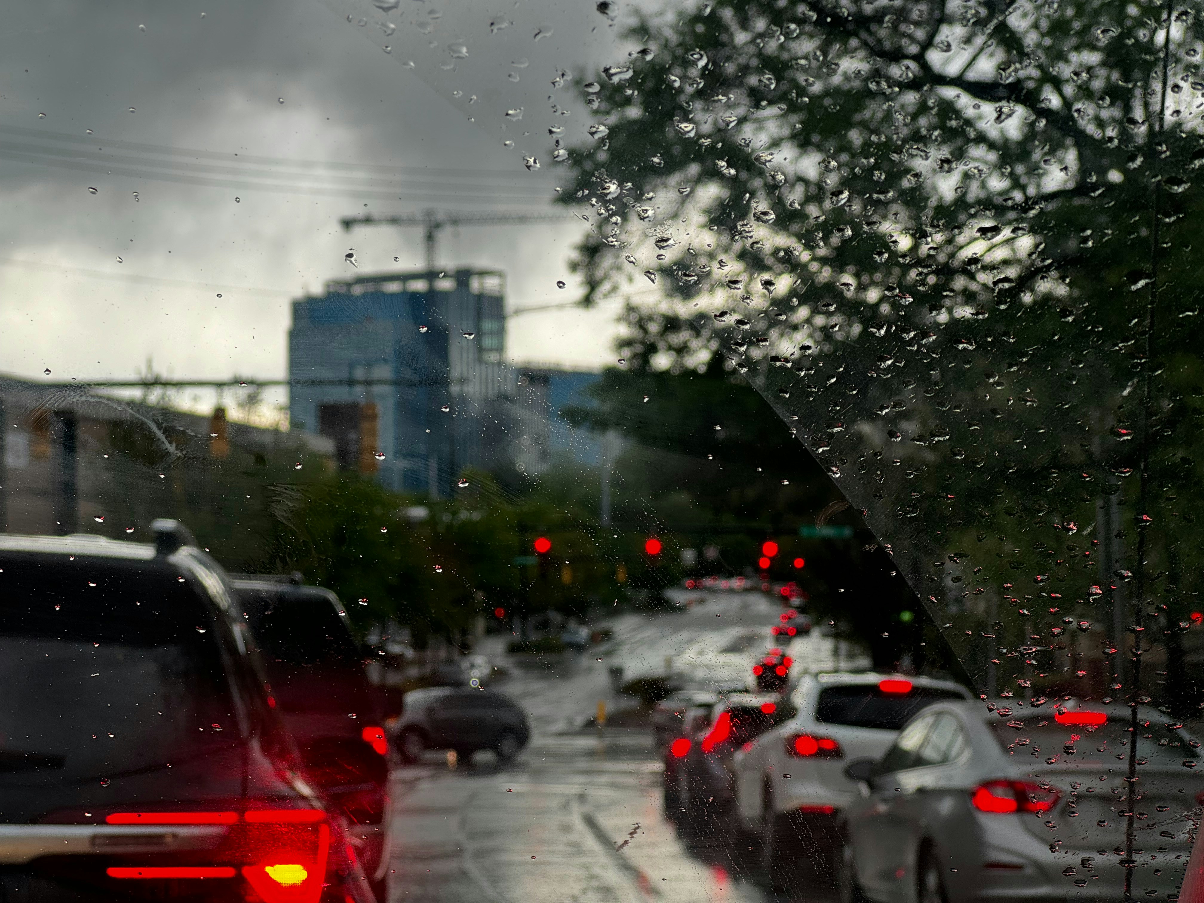 Converging Tail Lights on a Rain-Soaked Boulevard