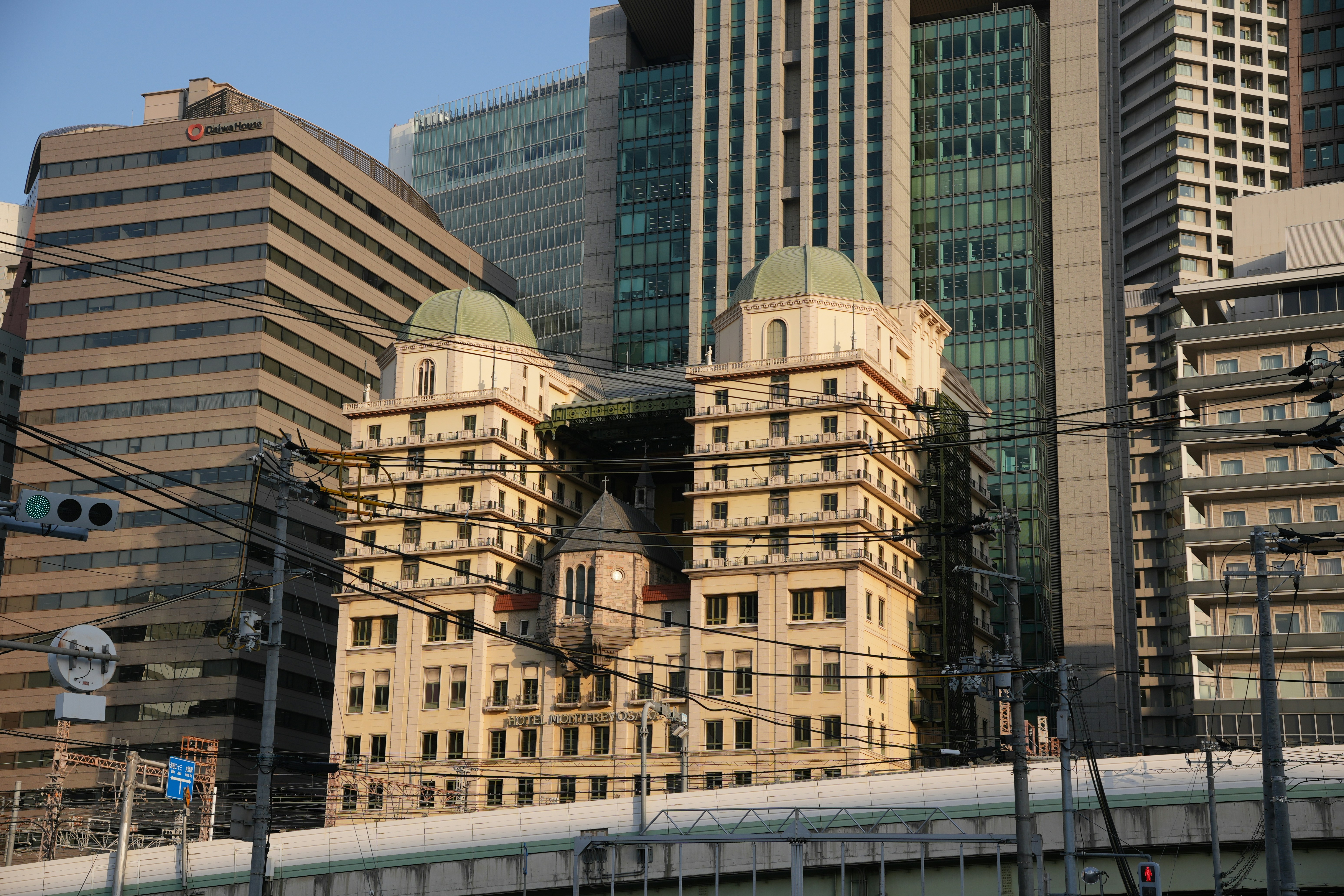 A train traveling through a city next to tall buildings photo – Free ...