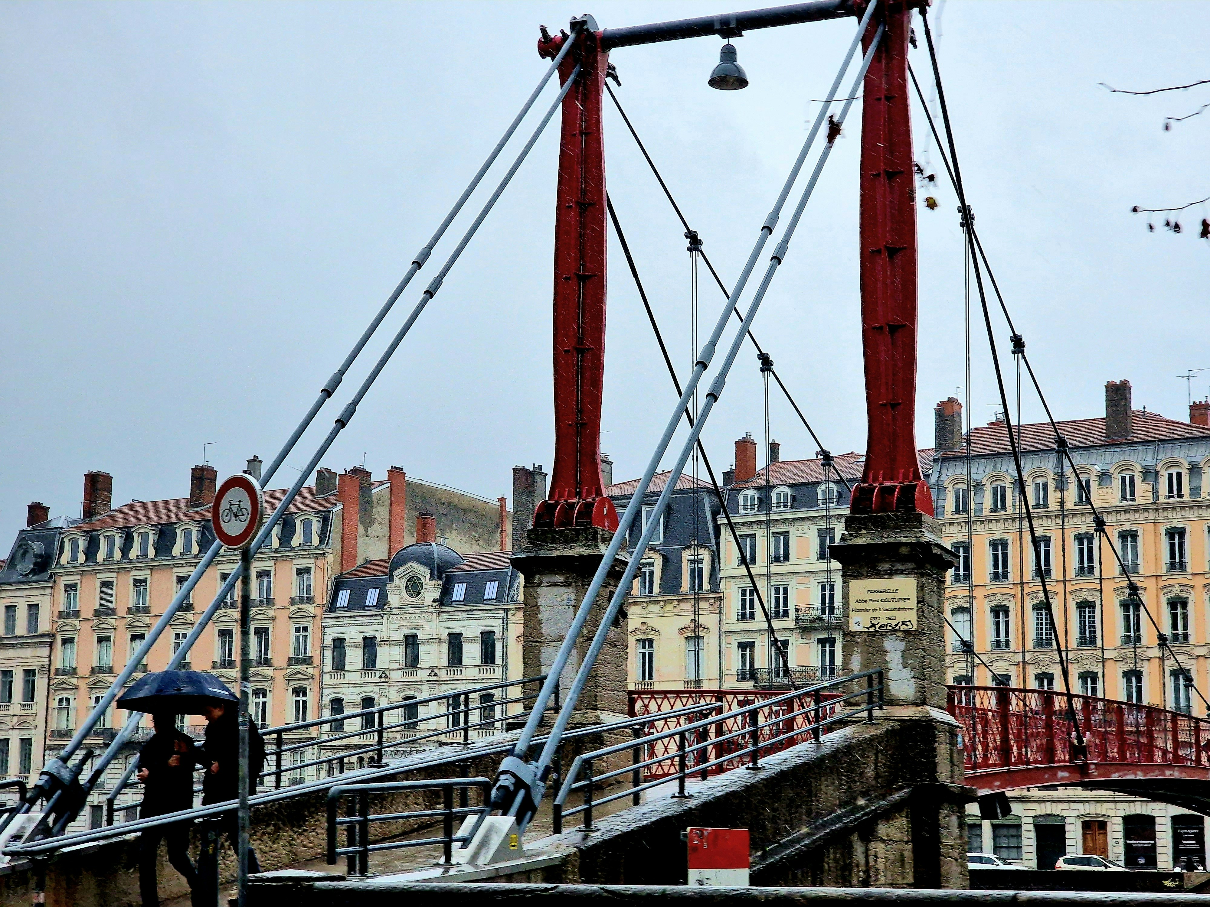 Crimson Pylons Framing a European Riverside