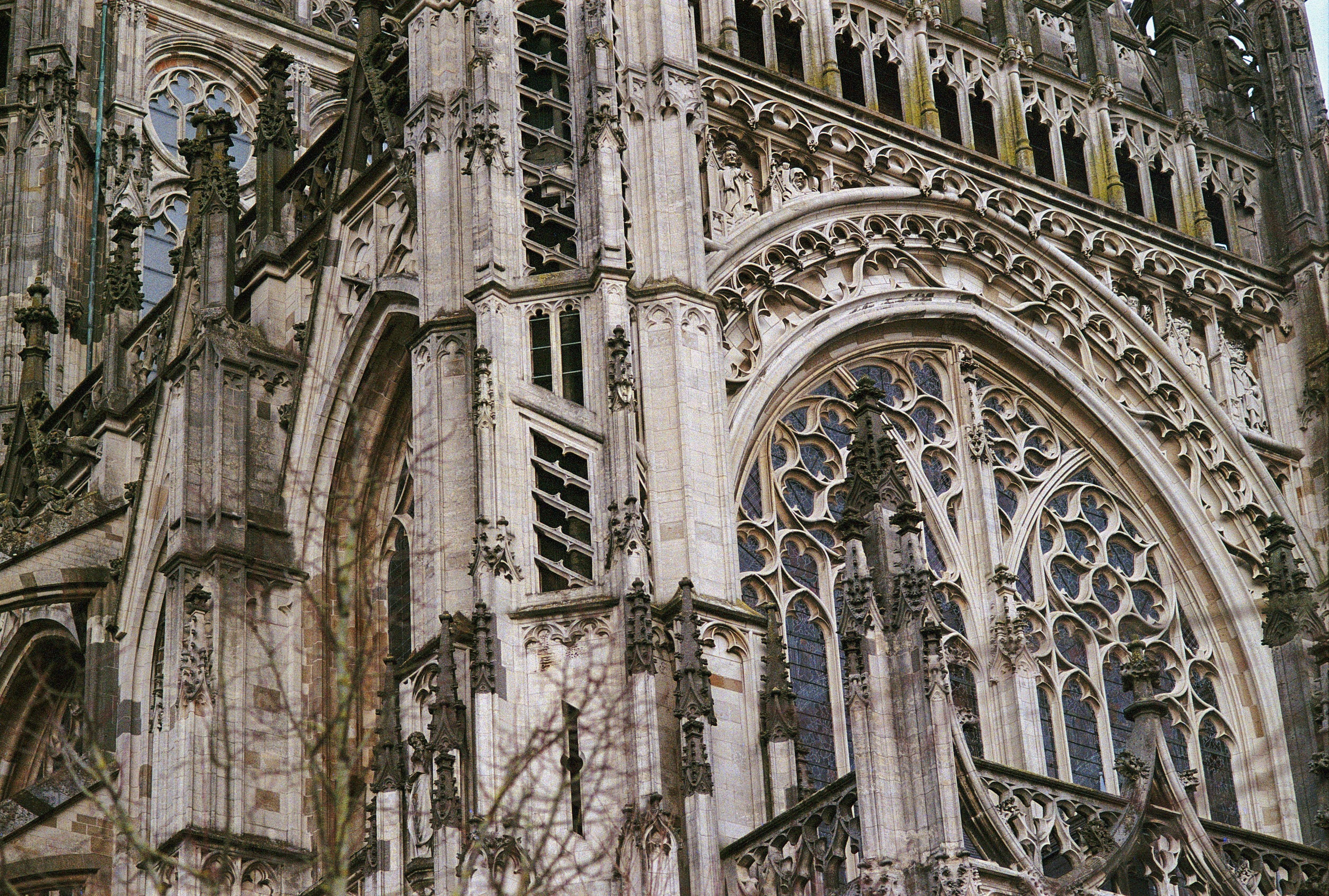 Detailed Gothic cathedral facade showcasing intricate stone carvings and arched windows.