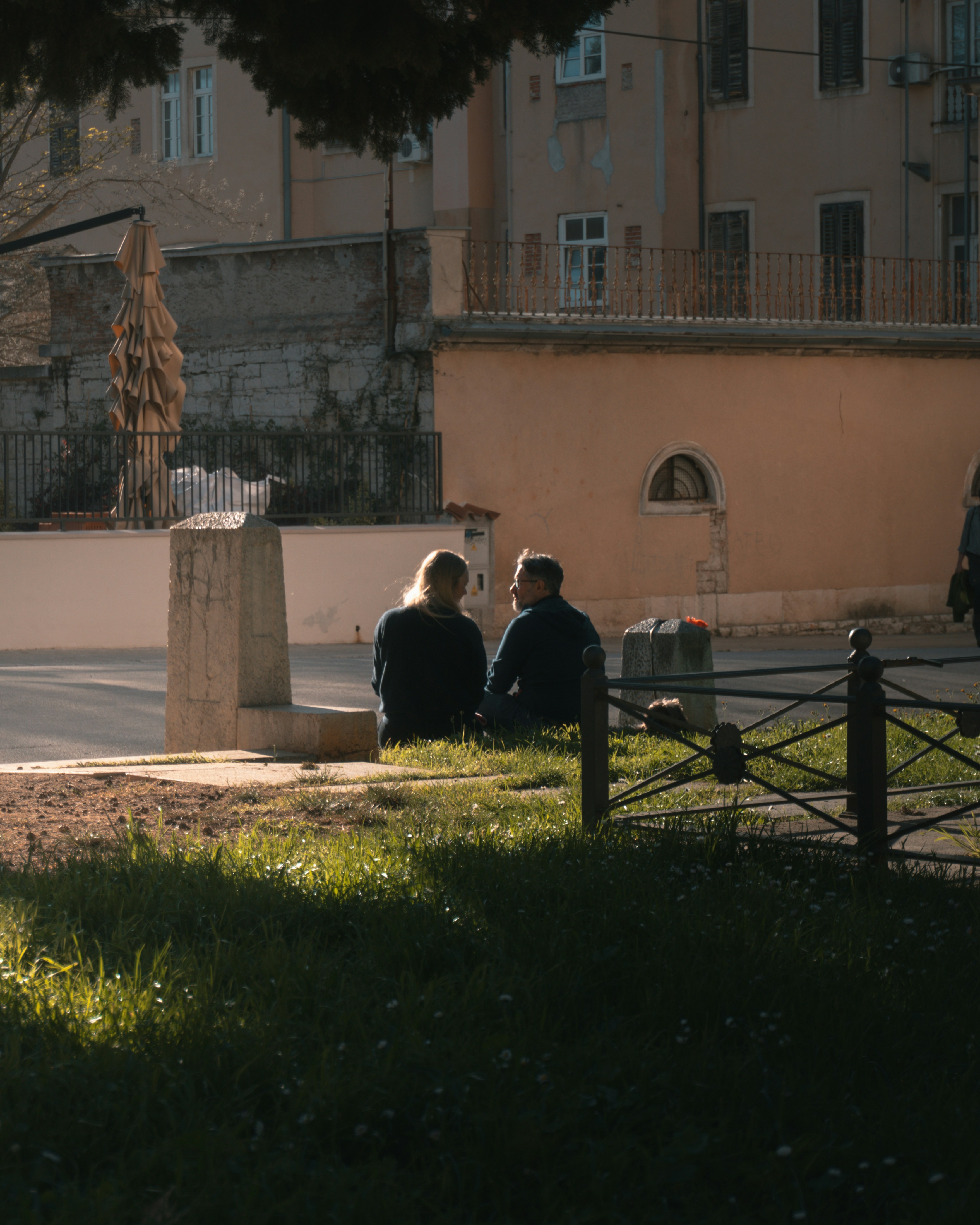Golden Hour Dialogue by a Weathered Courtyard Wall