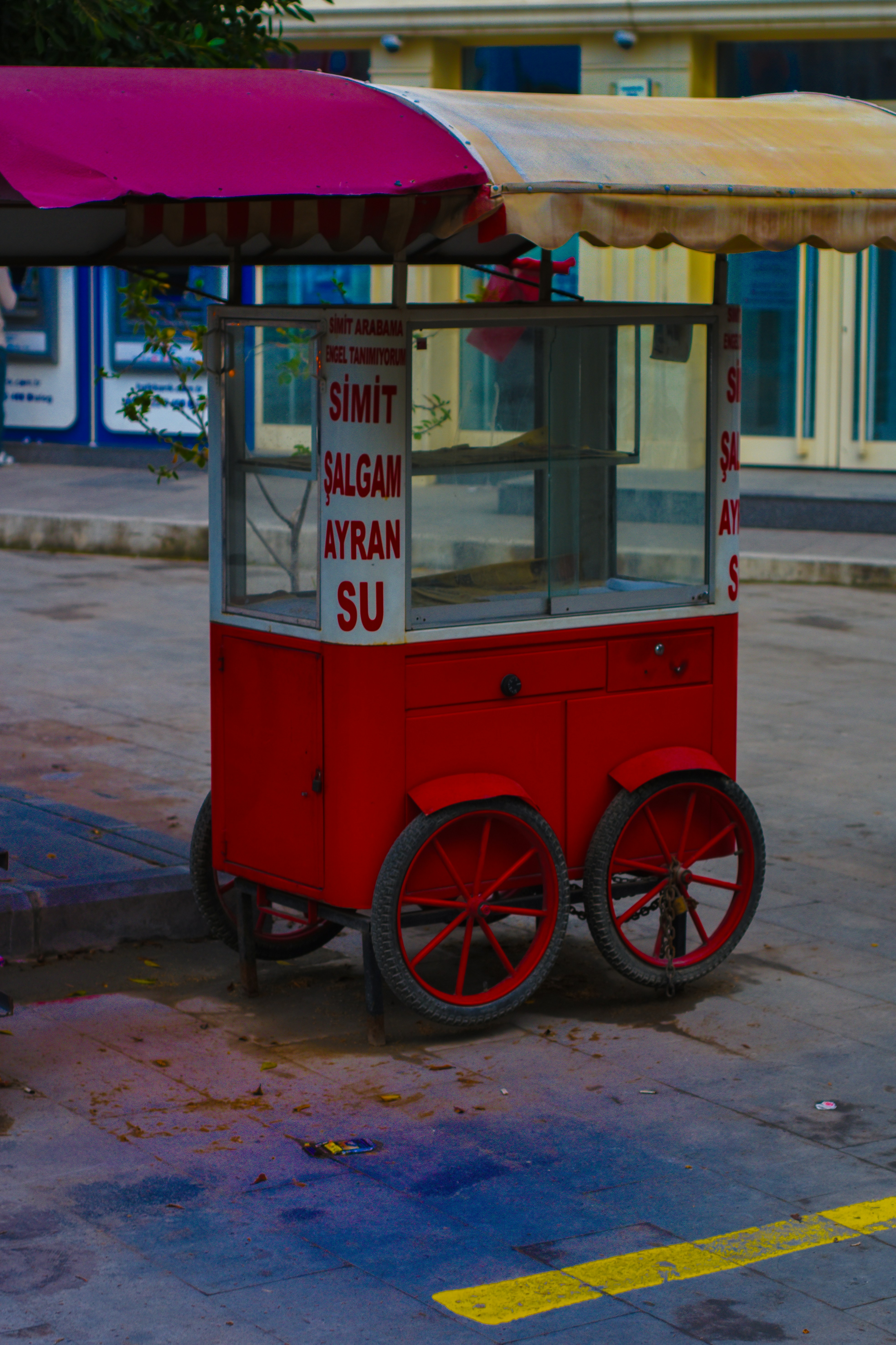 Crimson Snack Cart Under Colorful Awnings on a Turkish Street