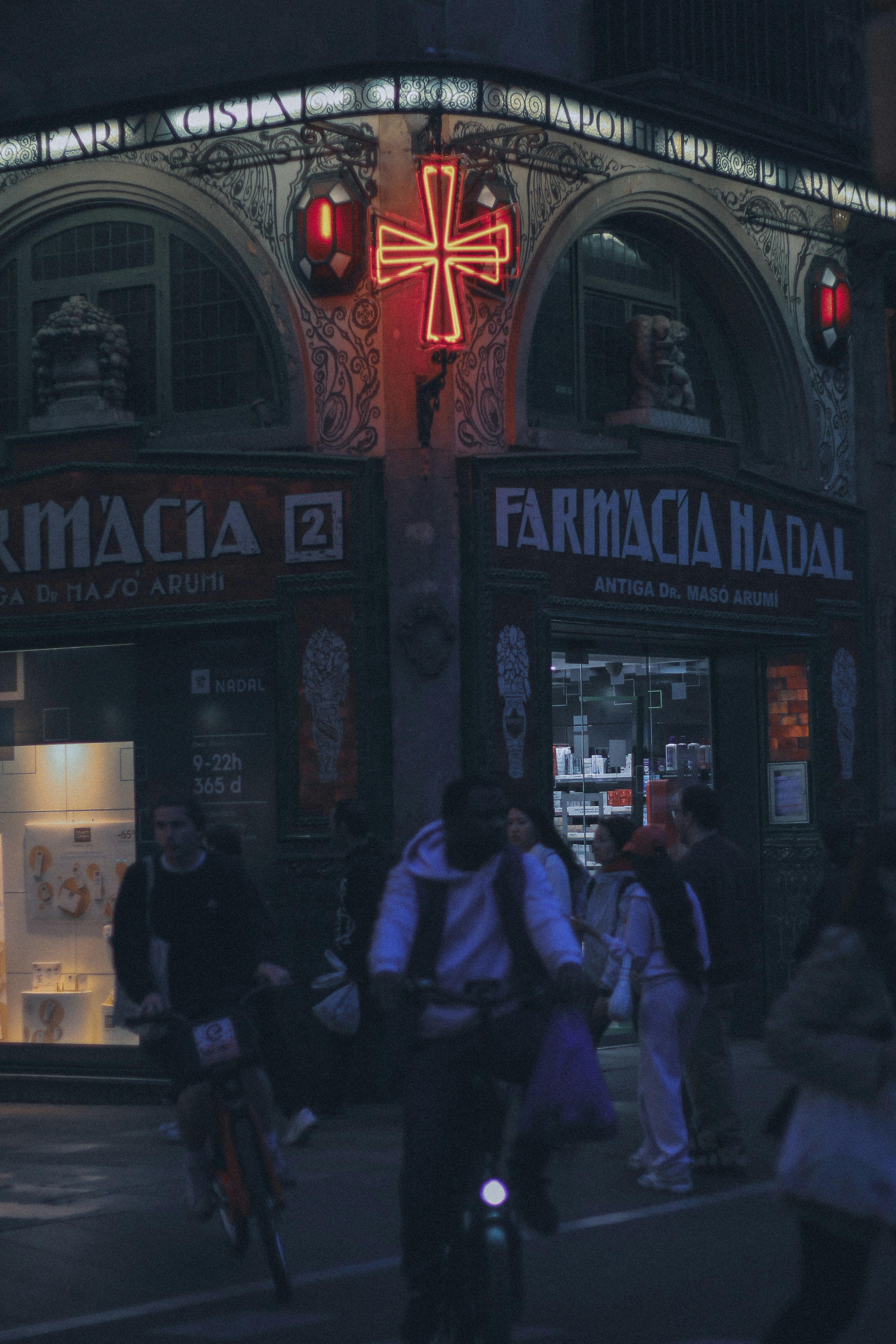 Crimson Neon Cross Illuminates a Nighttime Pharmacy Scene