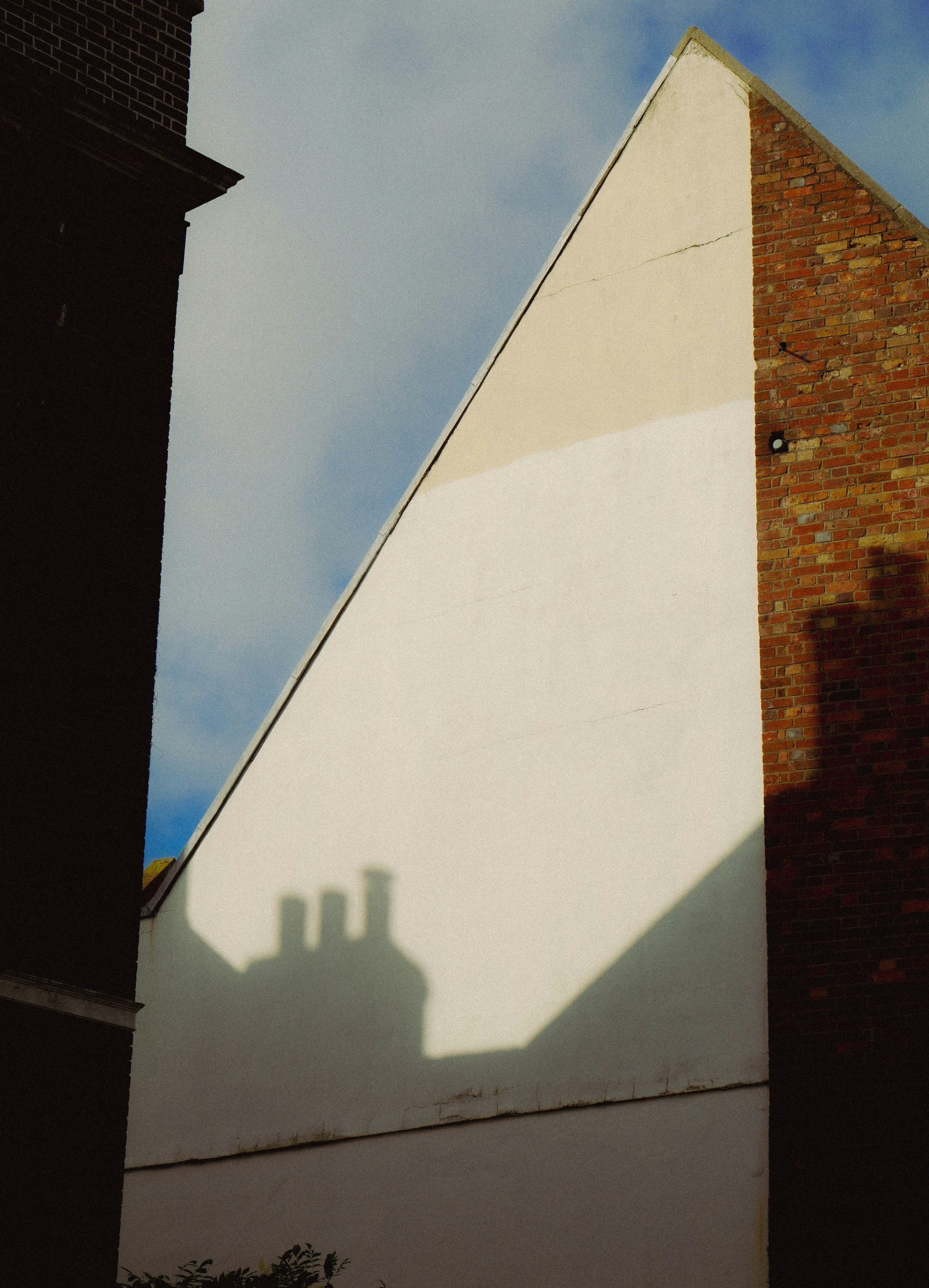 The shadow of a clock tower on the side of a building photo – Free Grey ...