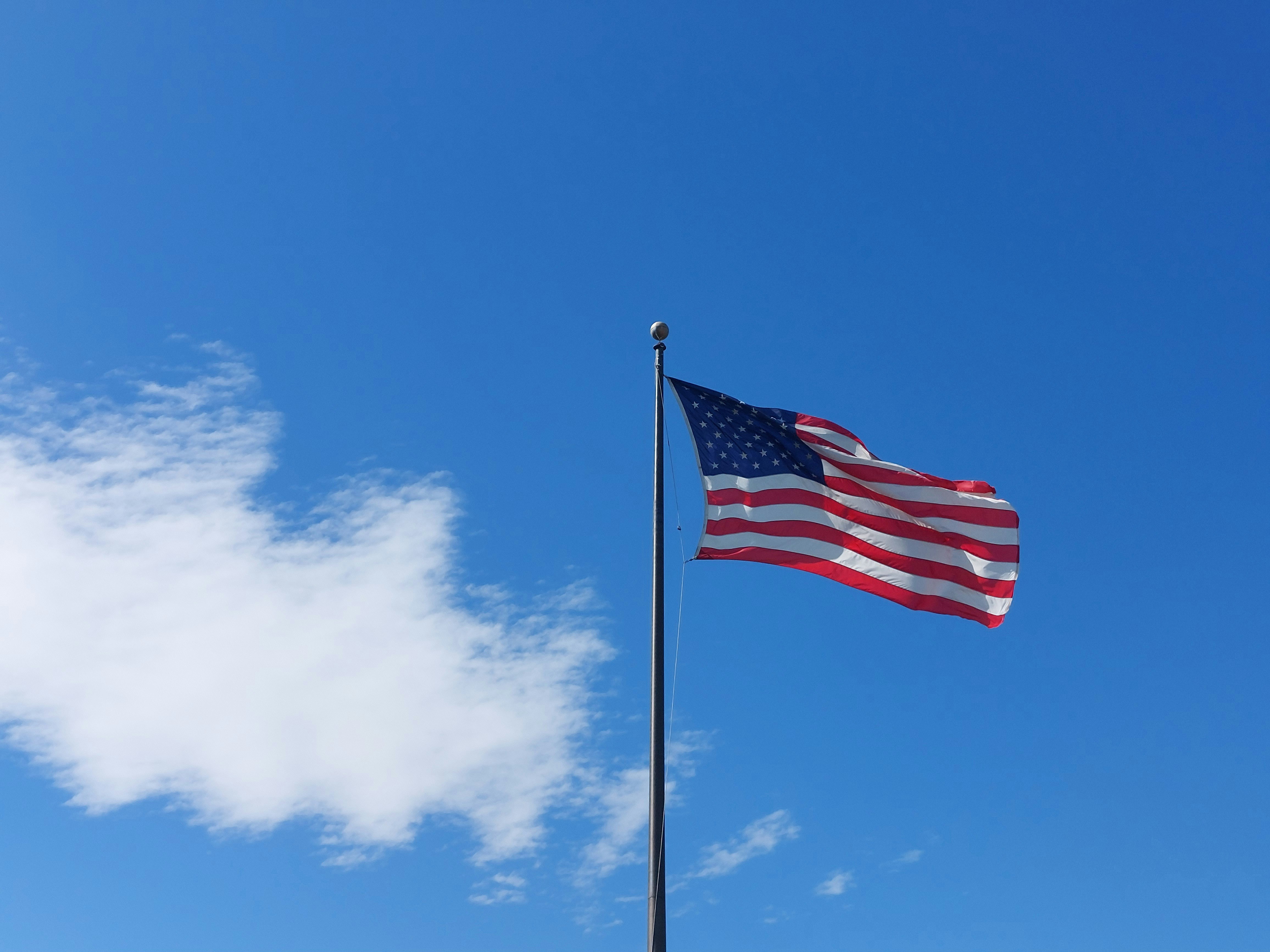 American flag flying high in brisk California wind at the San Jose Diridon Train Station