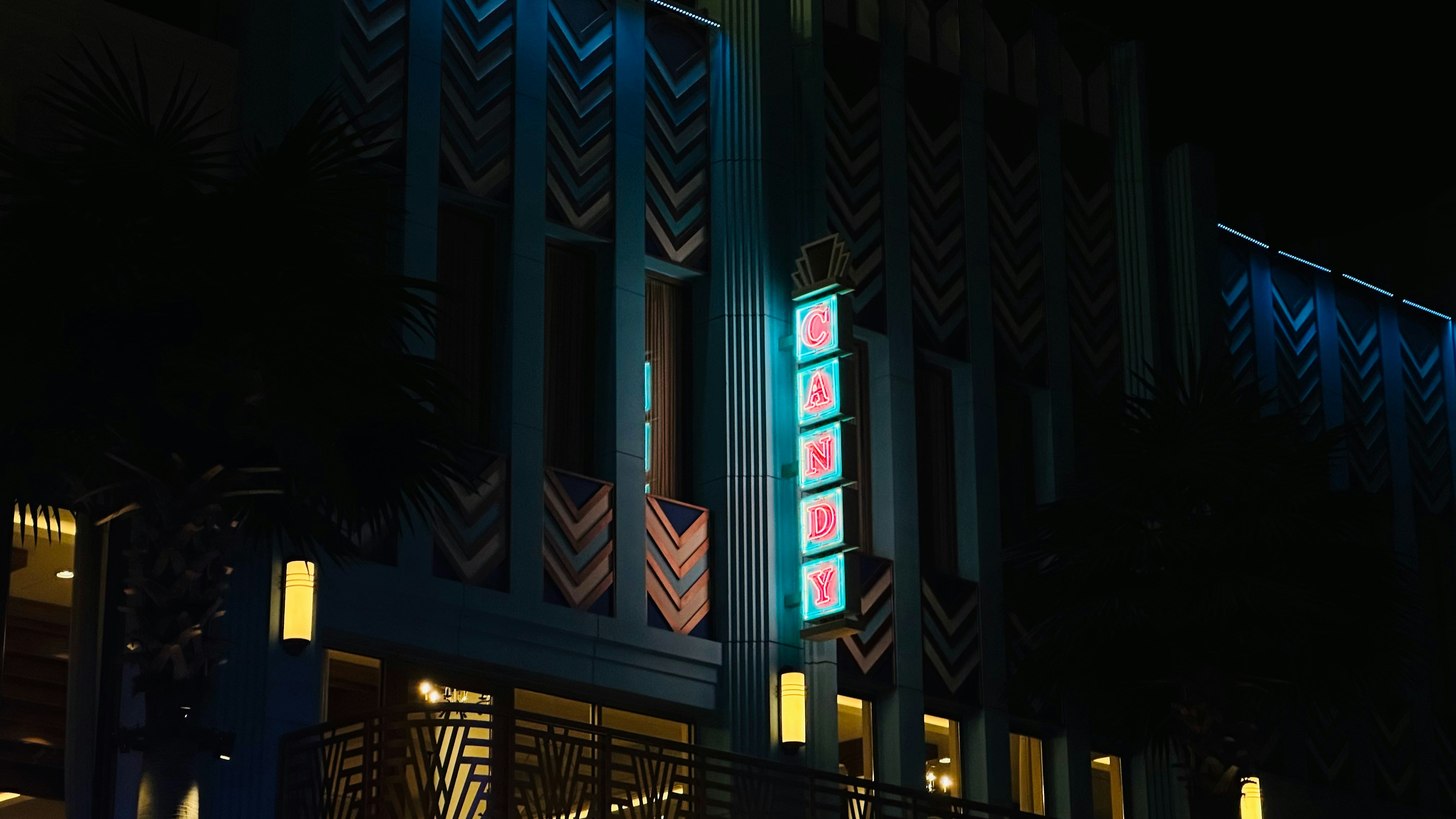 A tall building with a neon sign on it's side photo – Free 北京环球度假区 ...