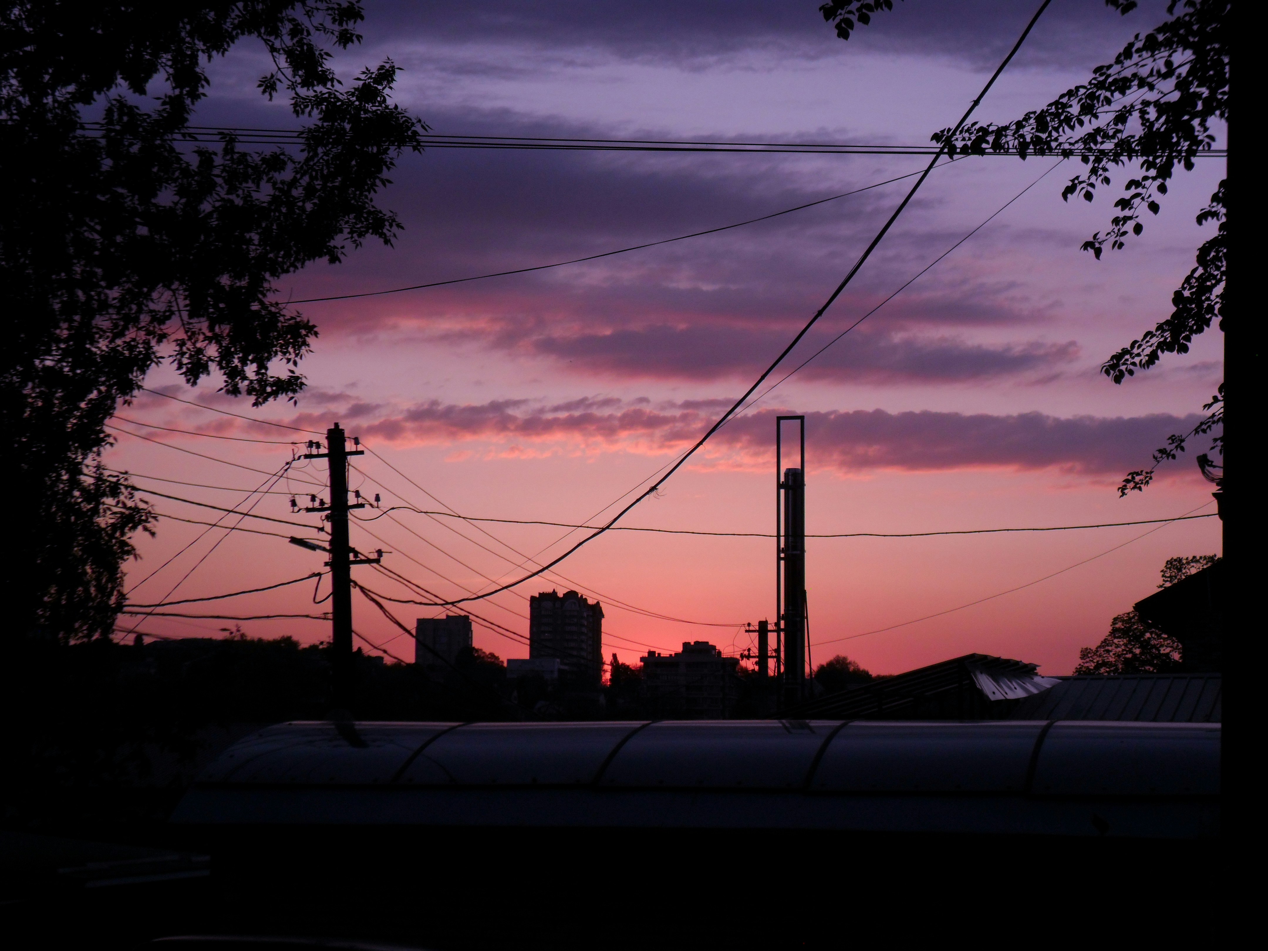 Crimson Horizon: Silhouette of a Suburban Skyline Threaded by Wires