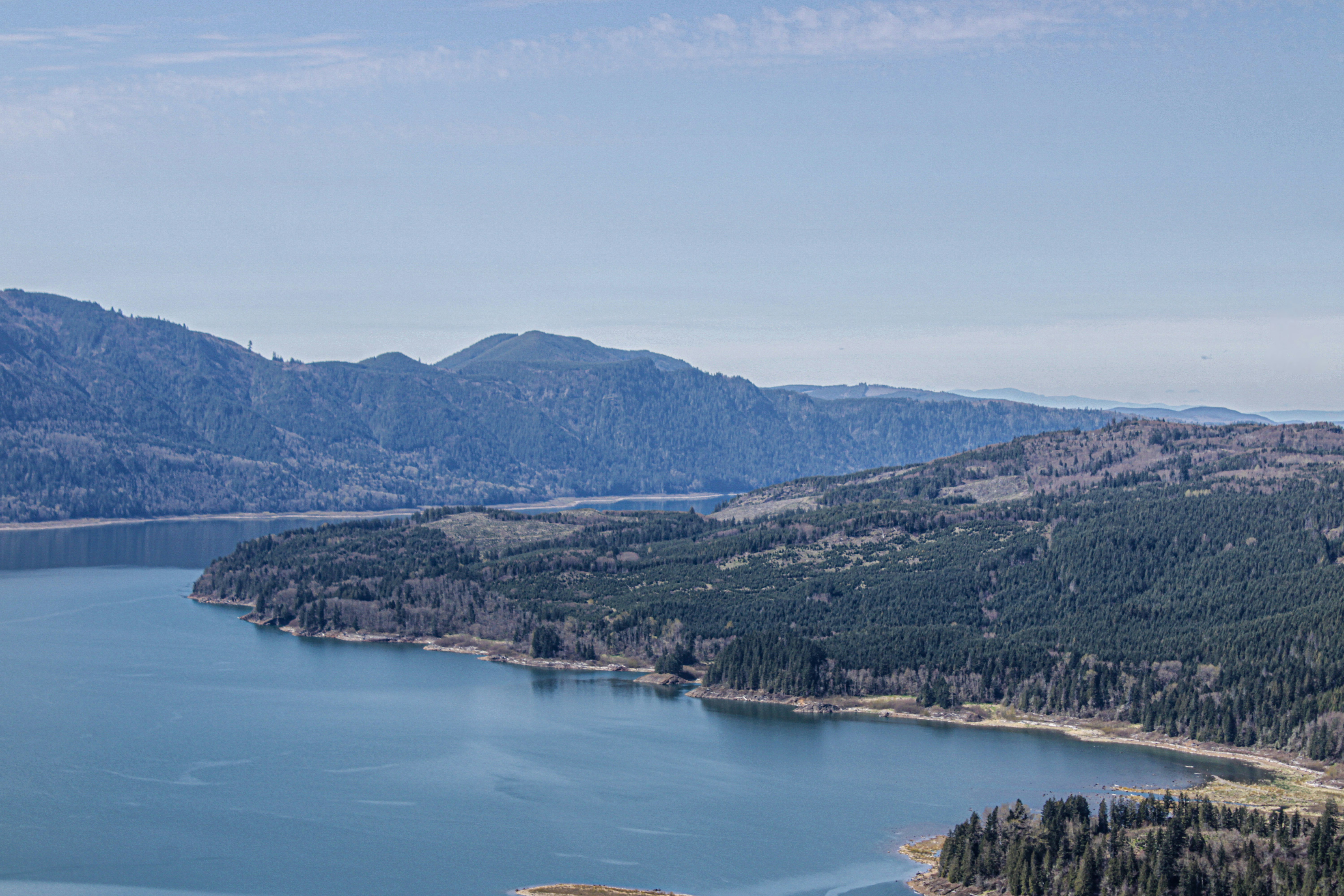 A large body of water surrounded by mountains photo – Free Riffe lake ...