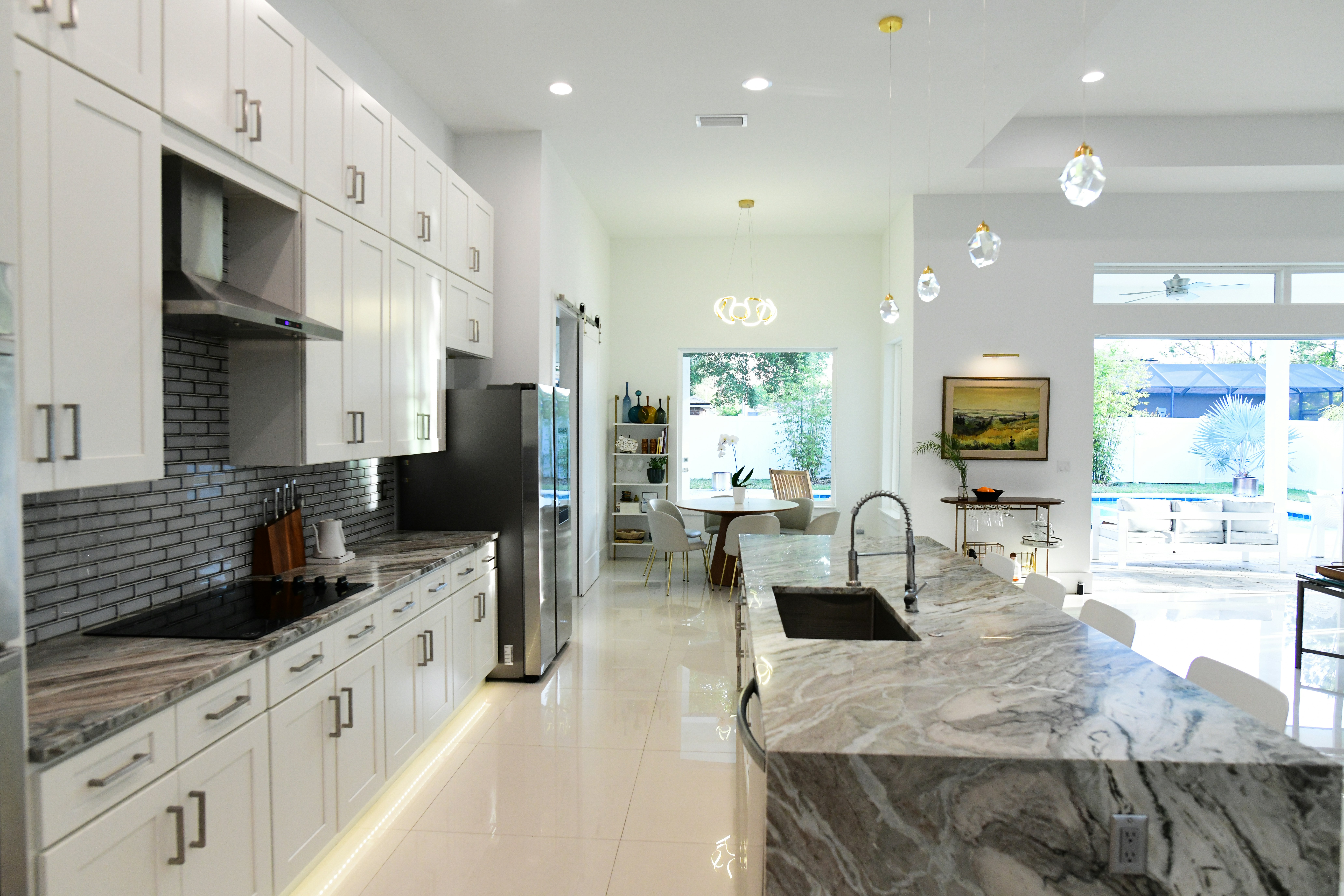 A kitchen with marble counter tops and white cabinets photo – Free Grey ...