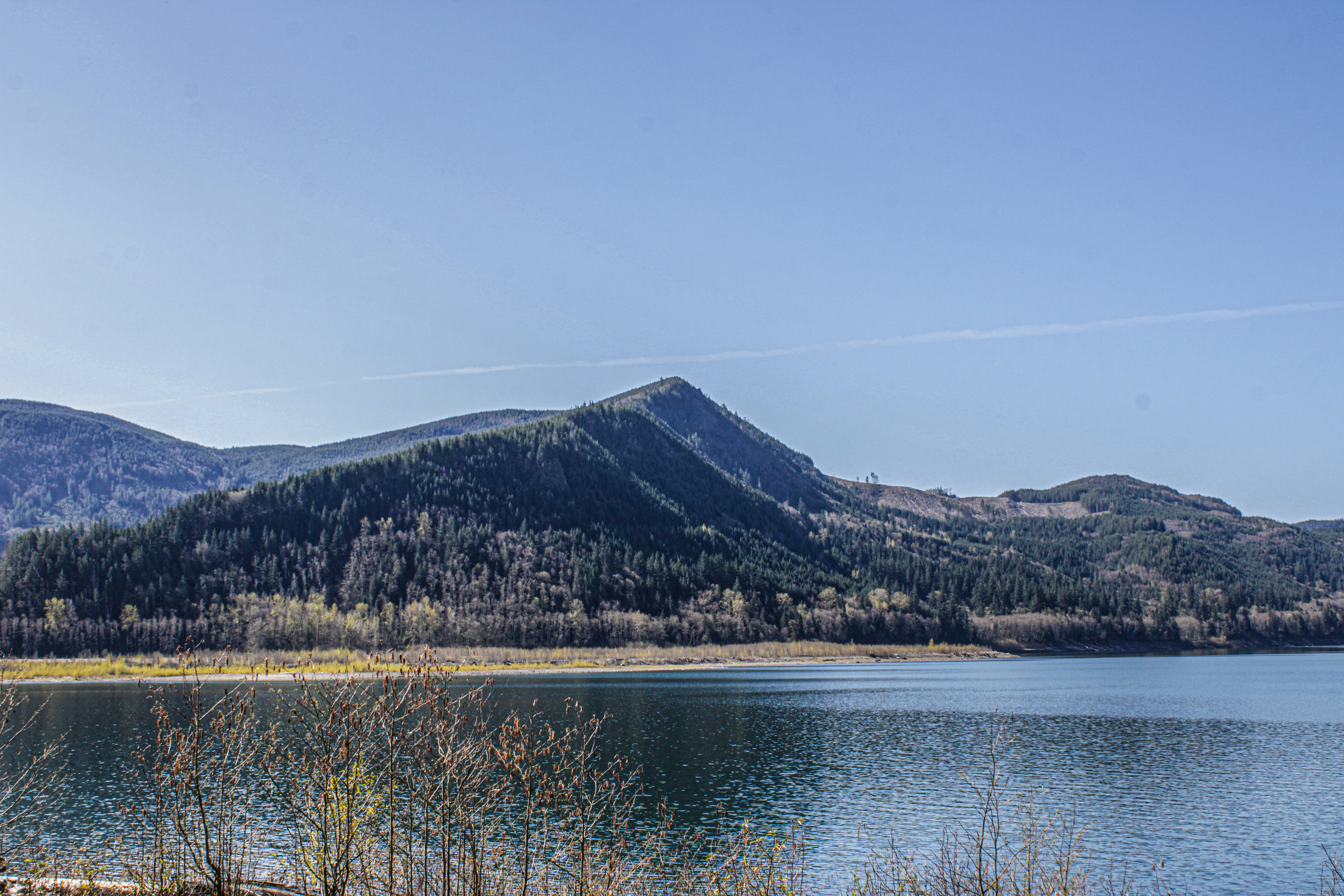 A large body of water surrounded by mountains photo – Free Riffe lake ...