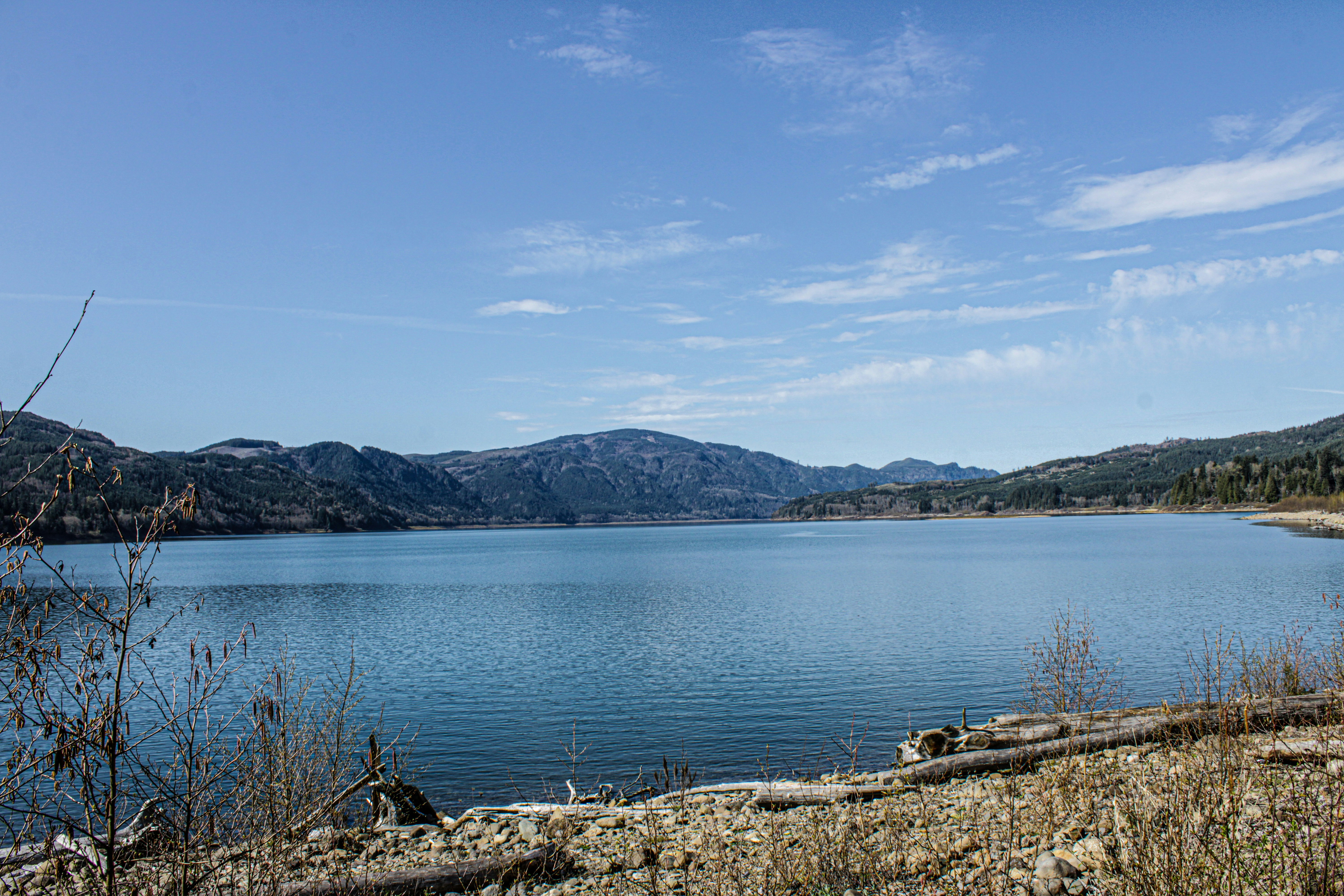 A large body of water surrounded by mountains photo – Free Riffe lake ...