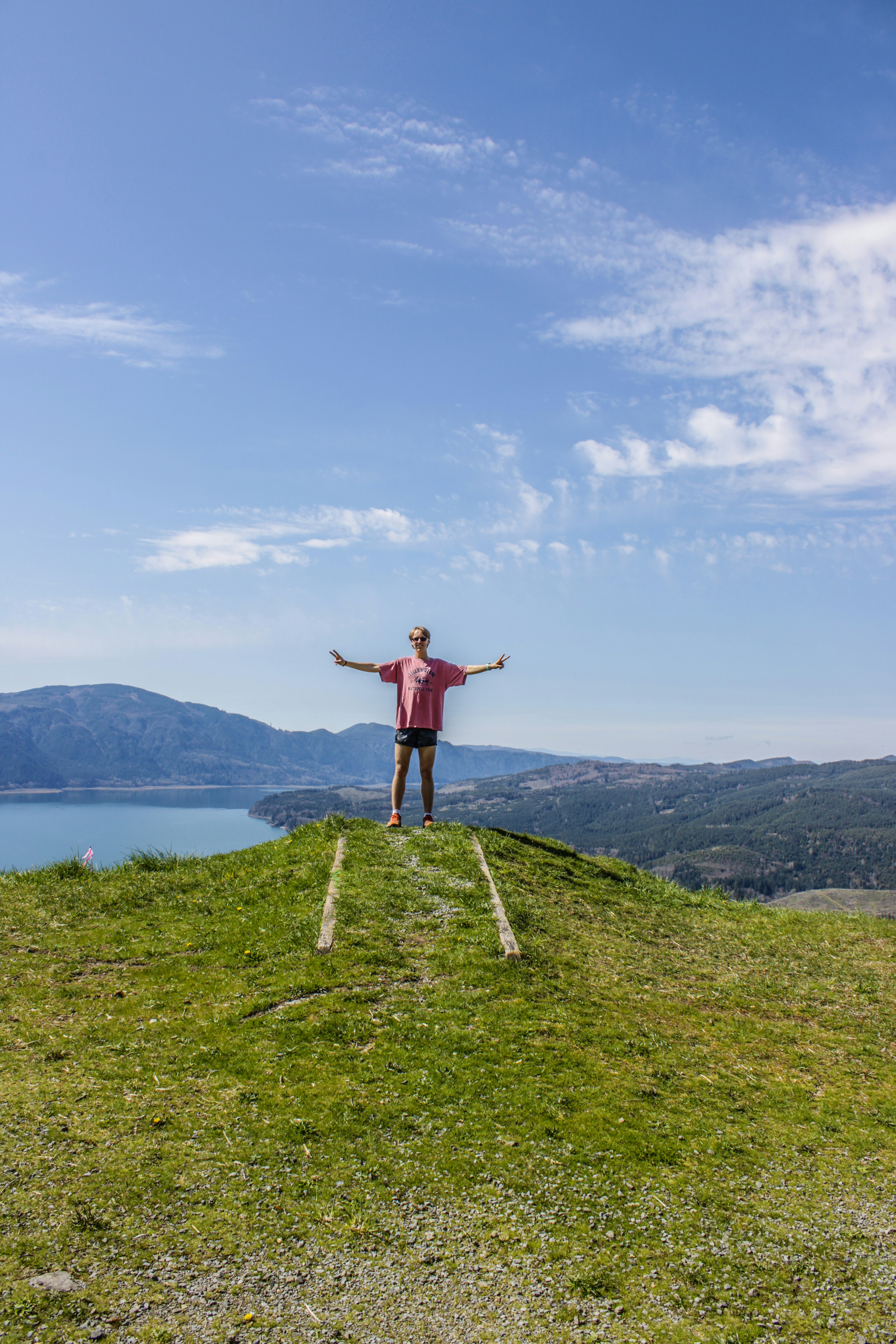 A man standing on top of a grass covered hill photo – Free Riffe lake ...