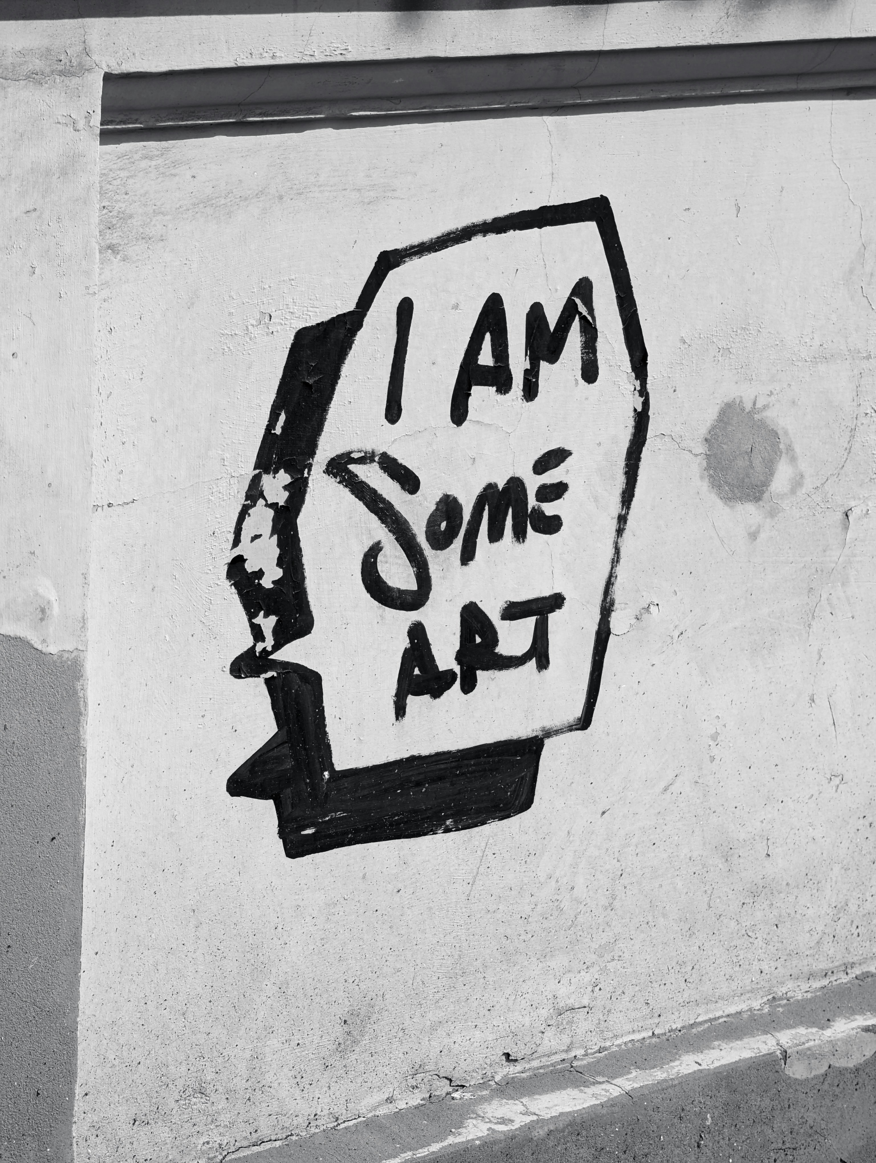 I Am Some Art: A Bold Graffiti Manifest on a Weathered Wall