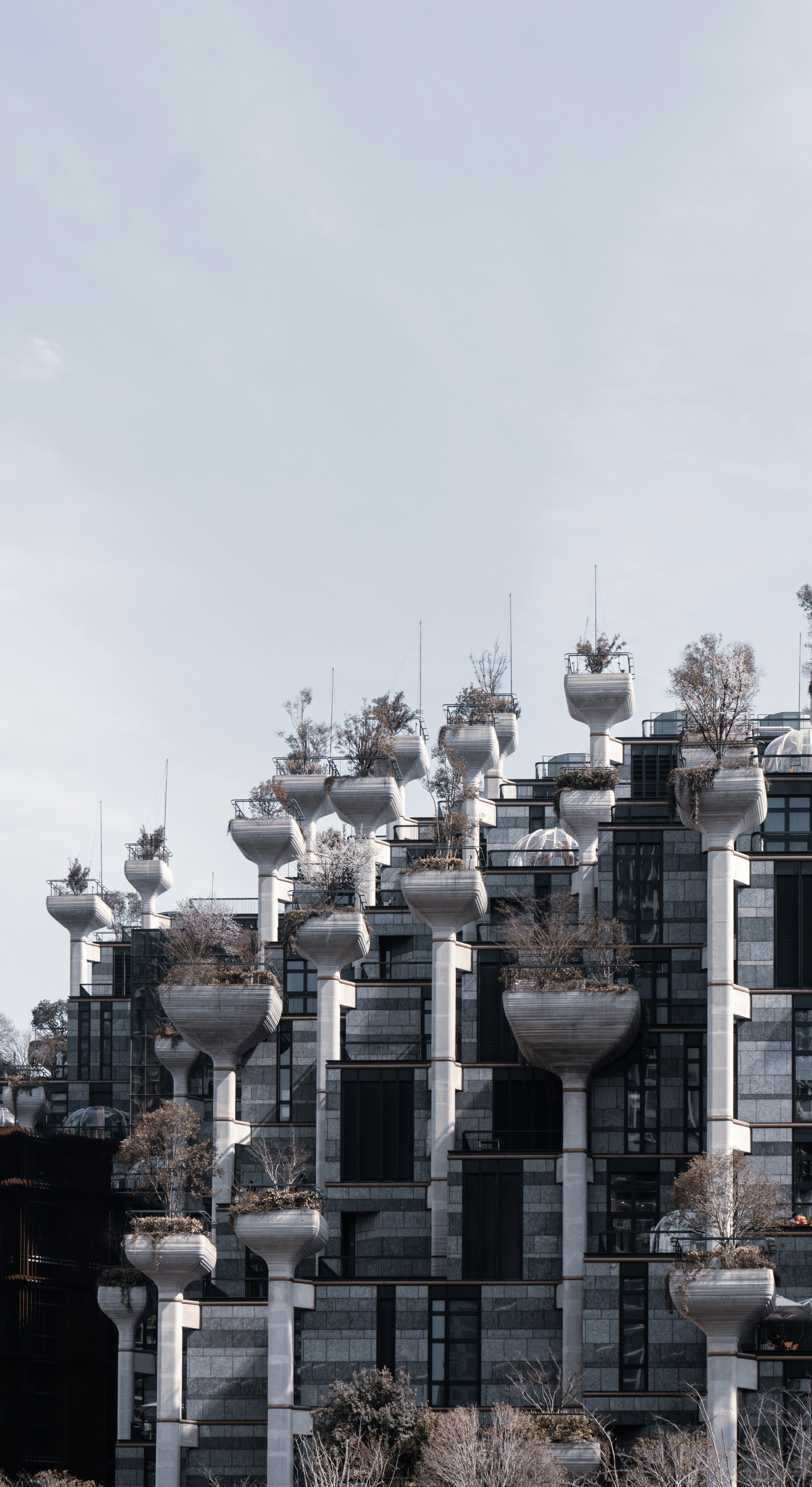 A very tall building with lots of planters on top of it photo – Free ...