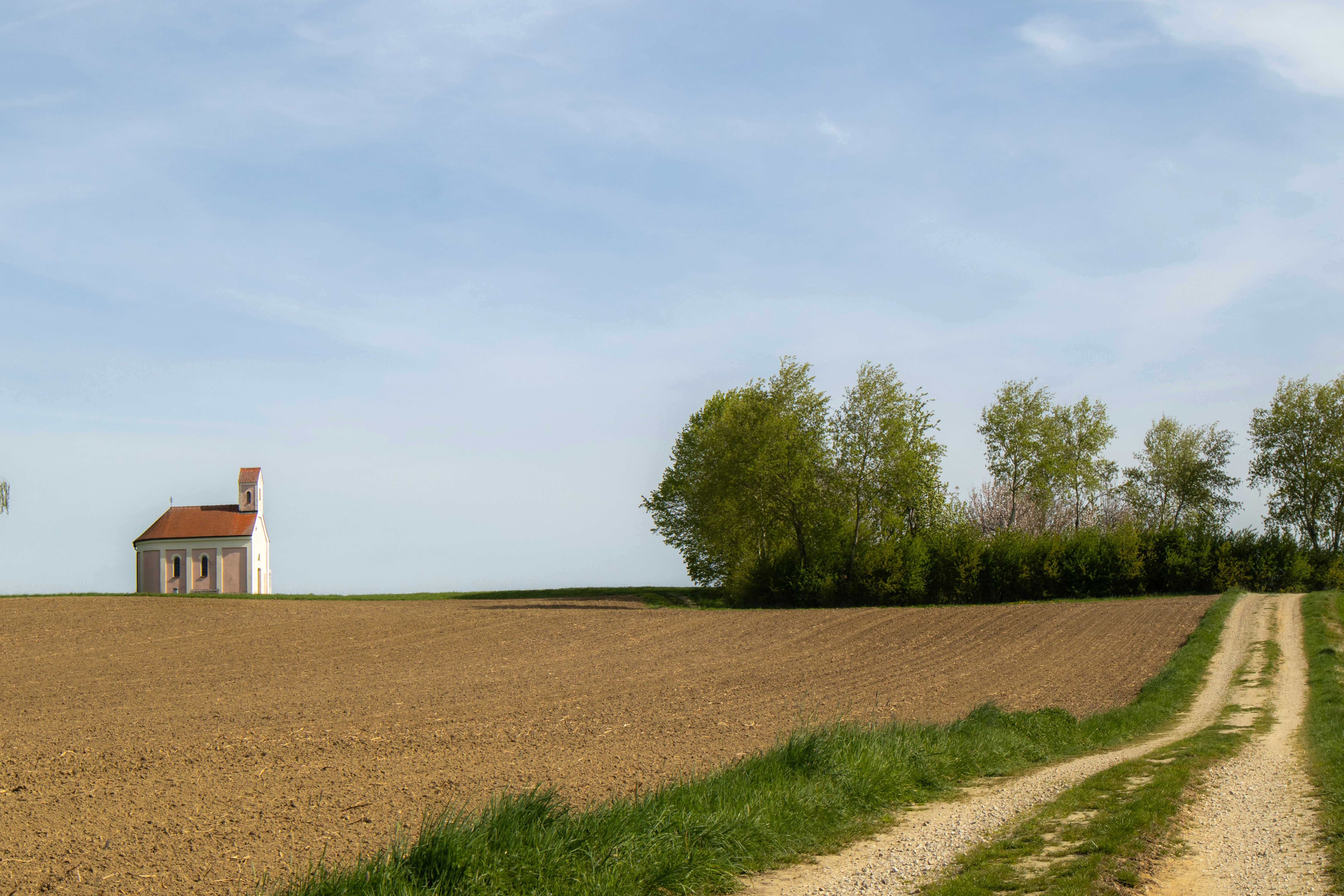 The Lone Farmhouse and the Ribbon of Road