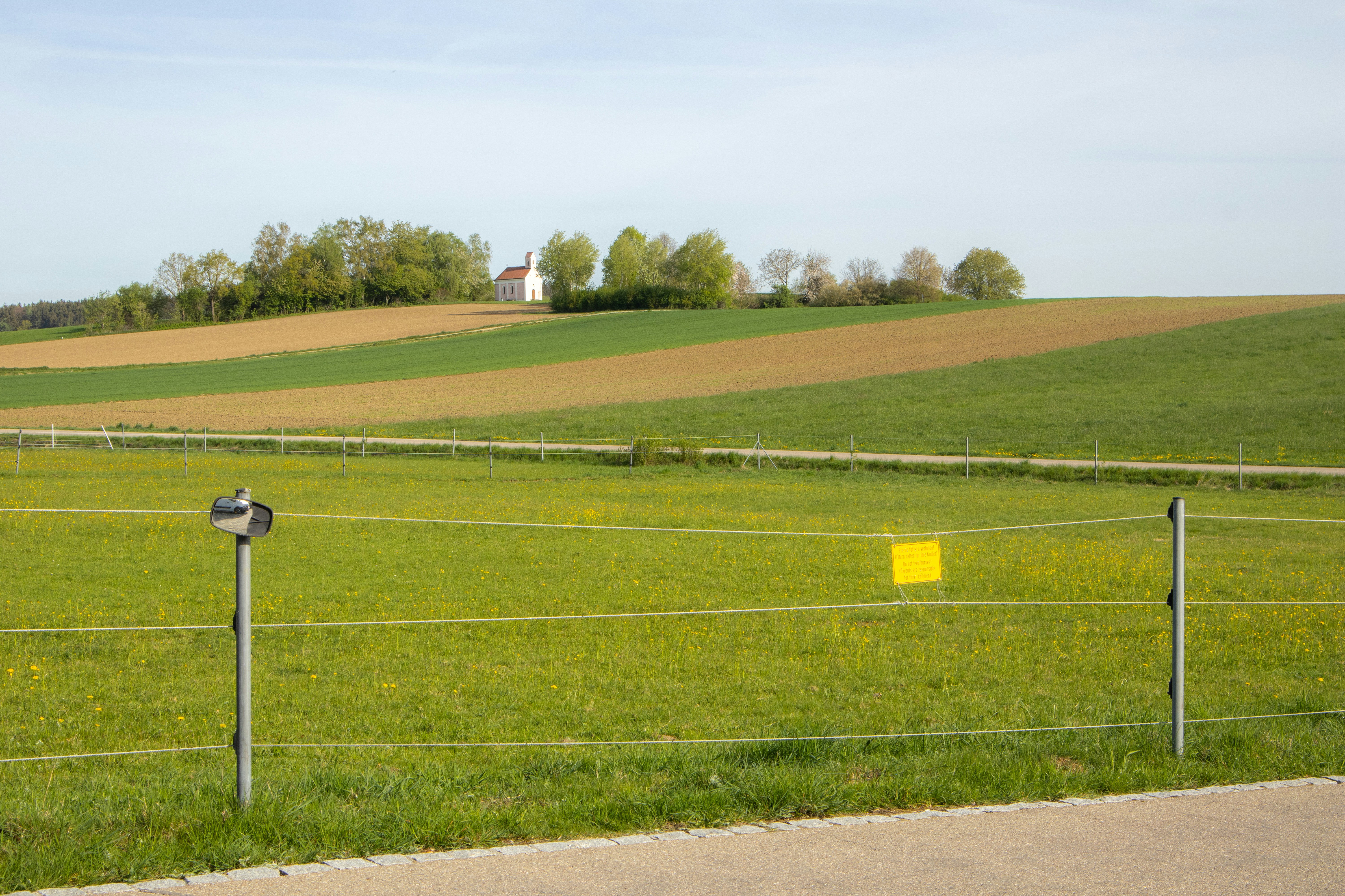 A fenced in field with a house in the distance photo – Free ...