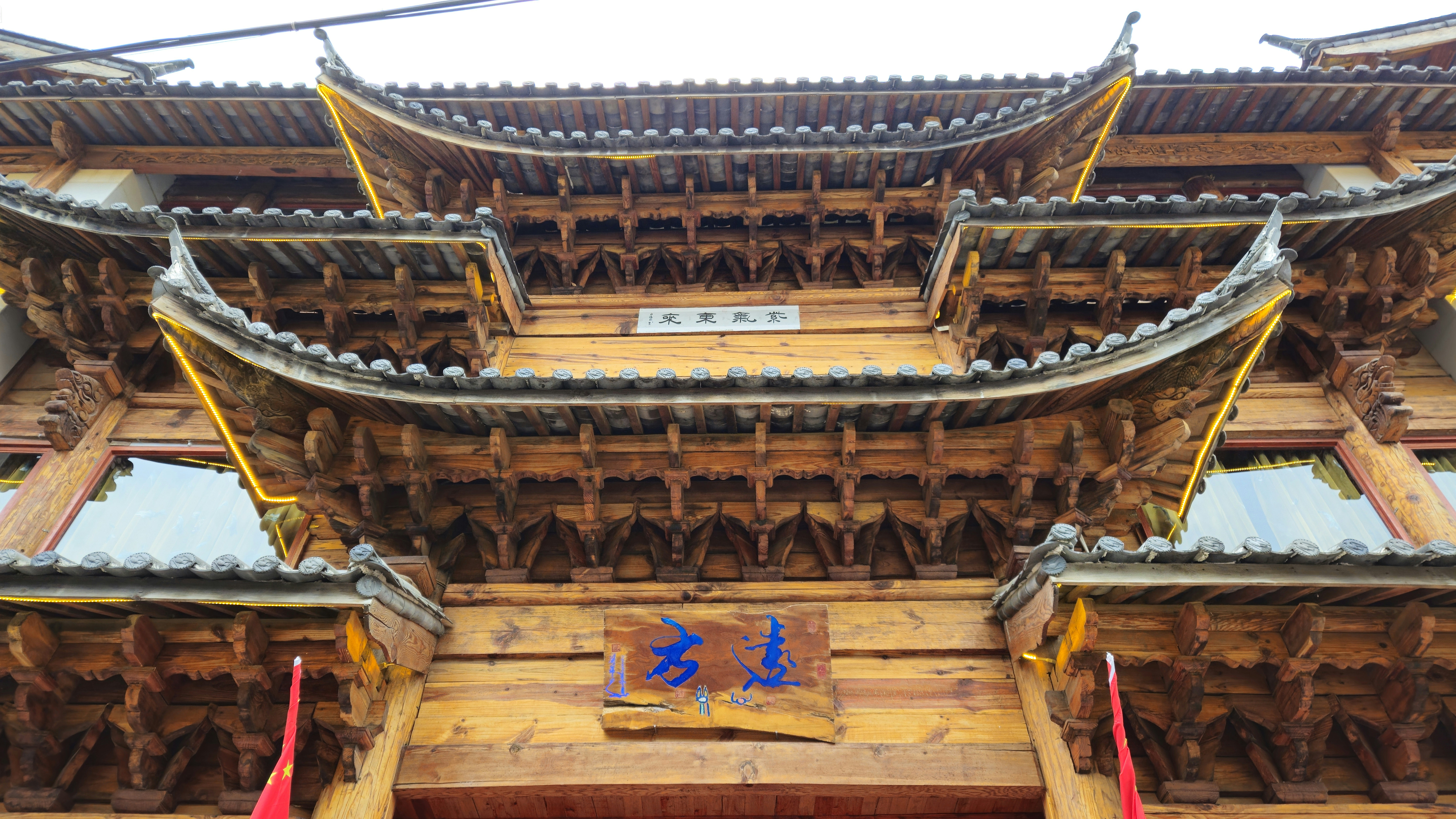 Traditional Tibetan-style wooden roof with ornate multi-tiered eaves in Lijiang, Yunnan, China.