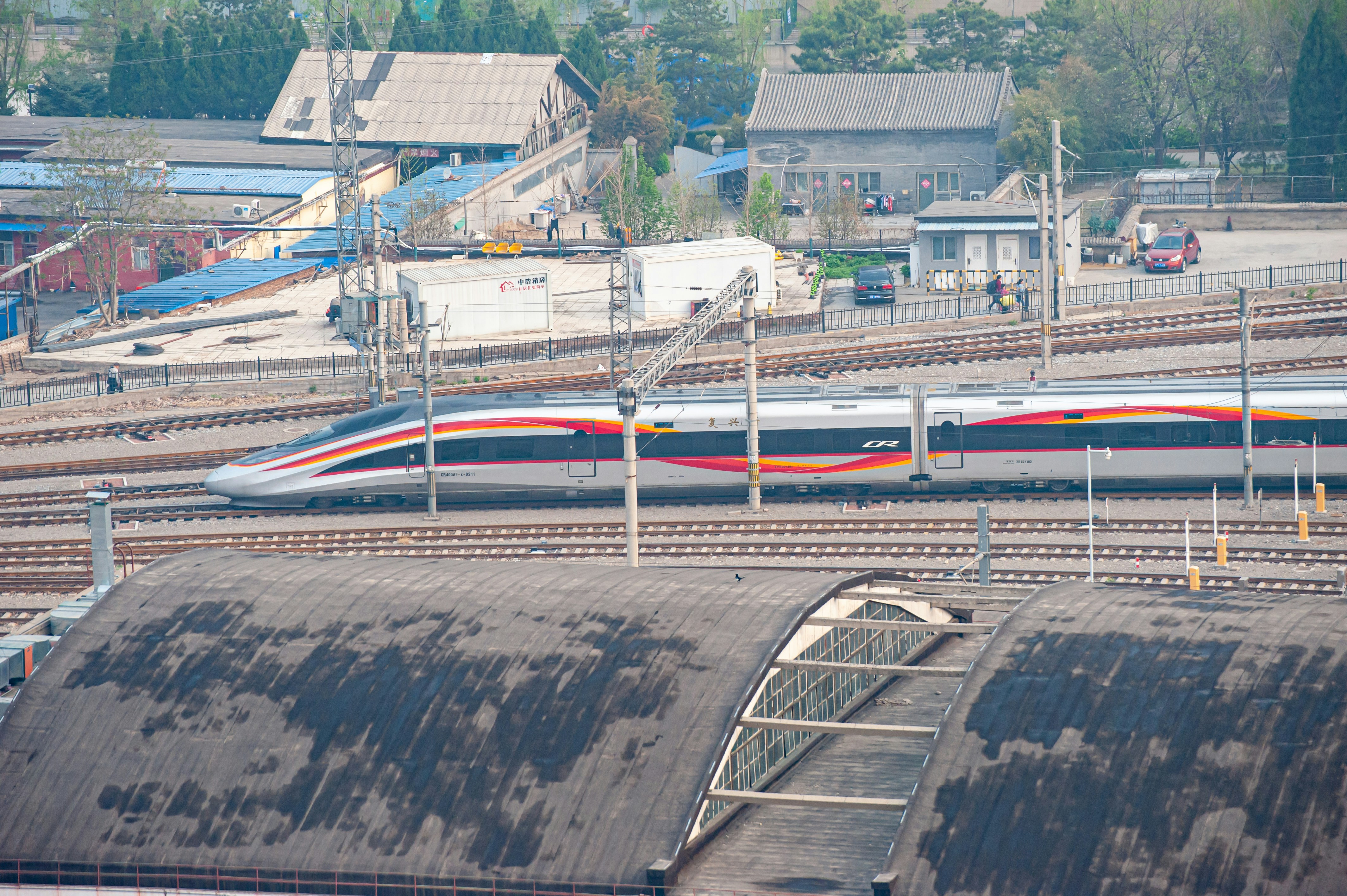 Silver Arrow on Rails: A Bullet Train Traverses a Curved-Roof Station