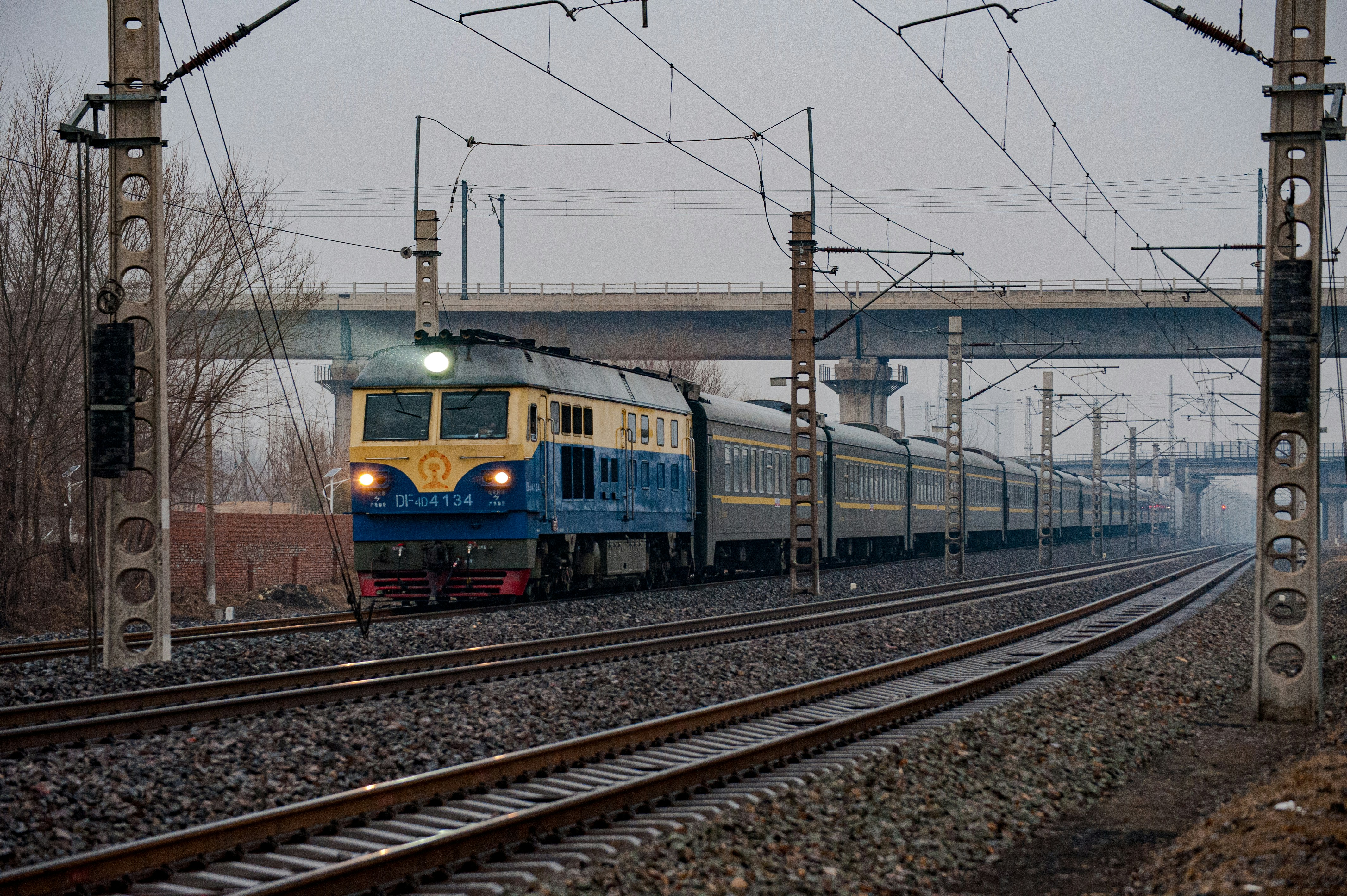 A blue and yellow train traveling down train tracks photo – Free Train ...