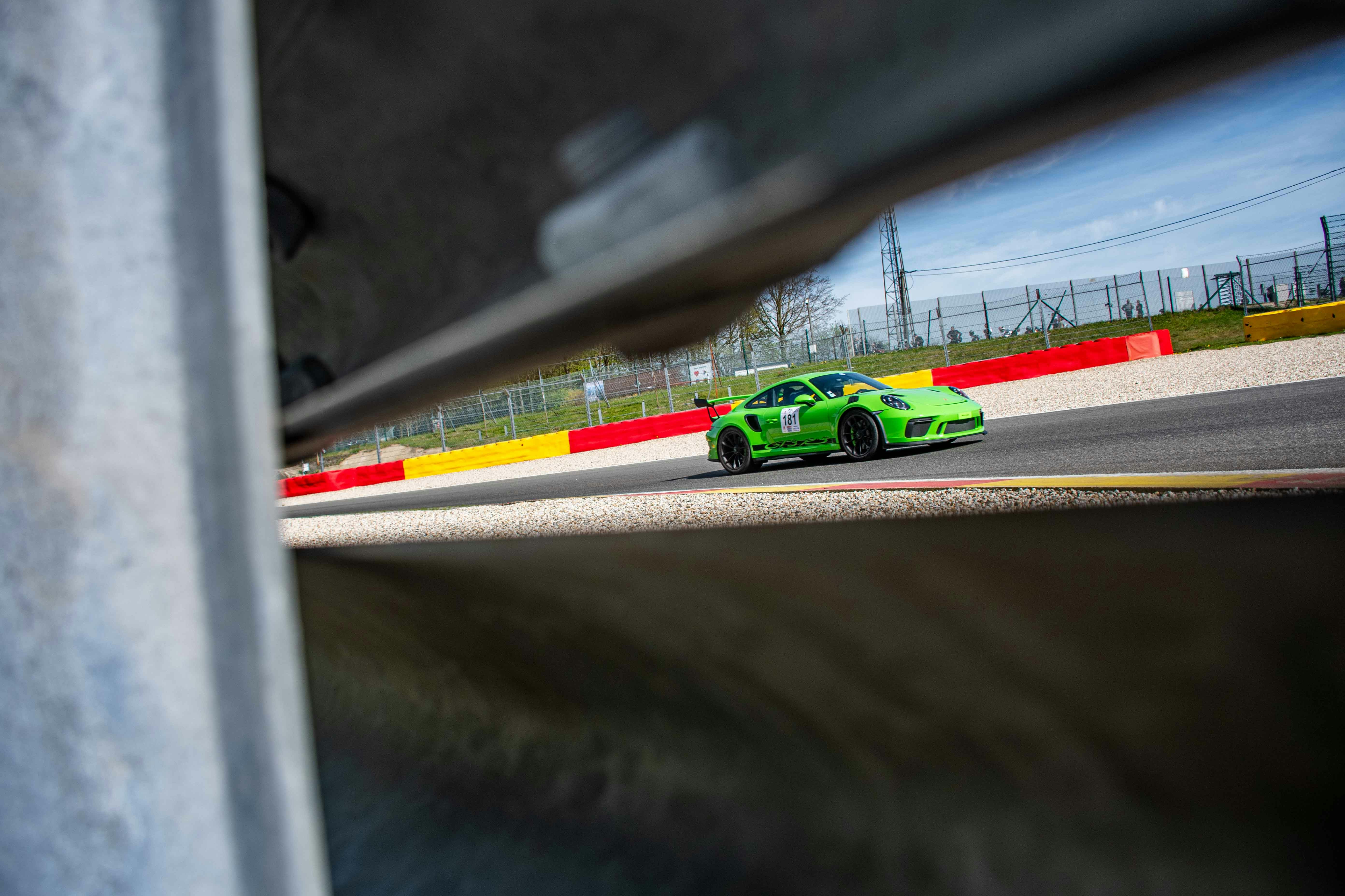 A green sports car driving down a race track photo – Free Spa ...