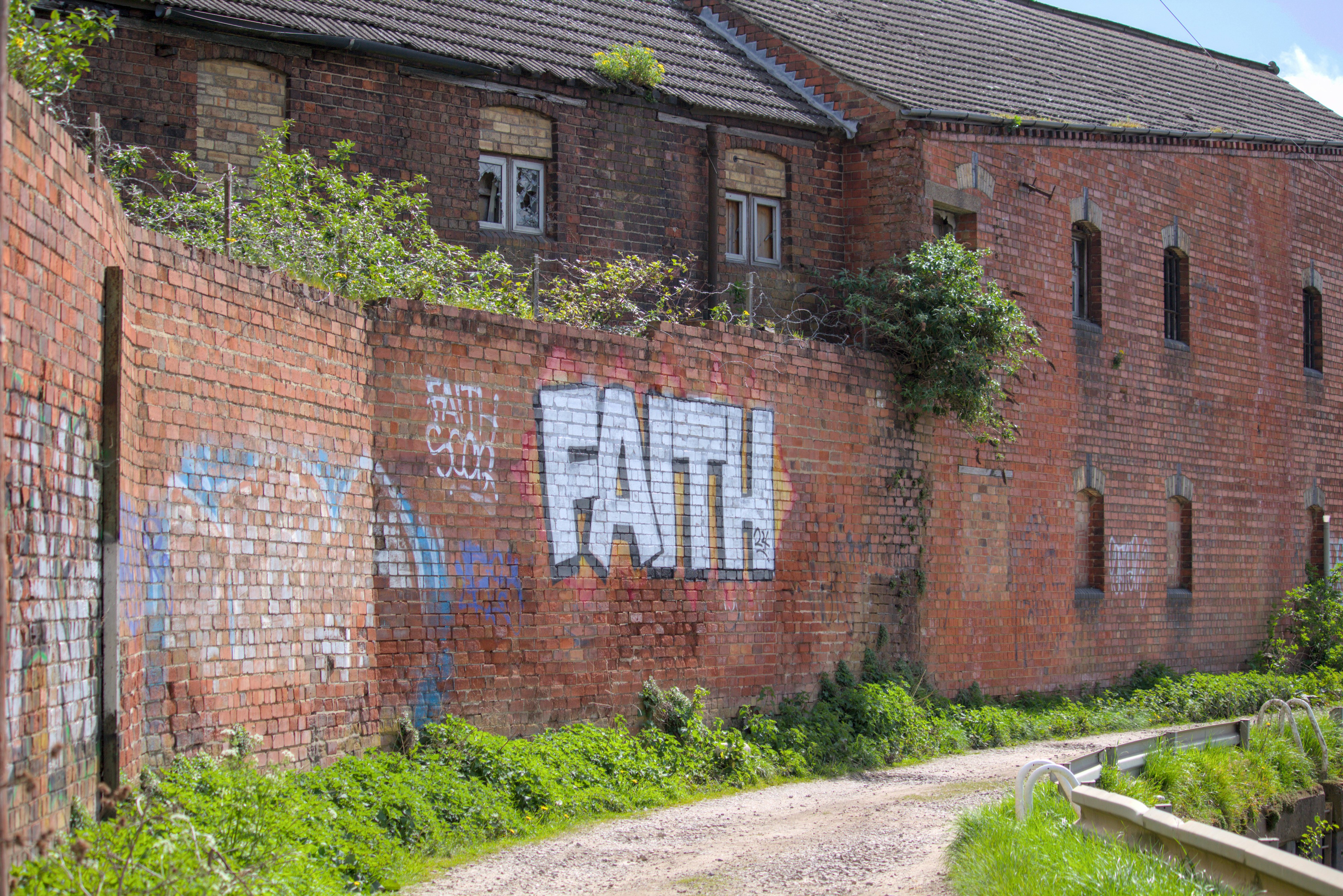 Faith on the Brick Wall by the Rails