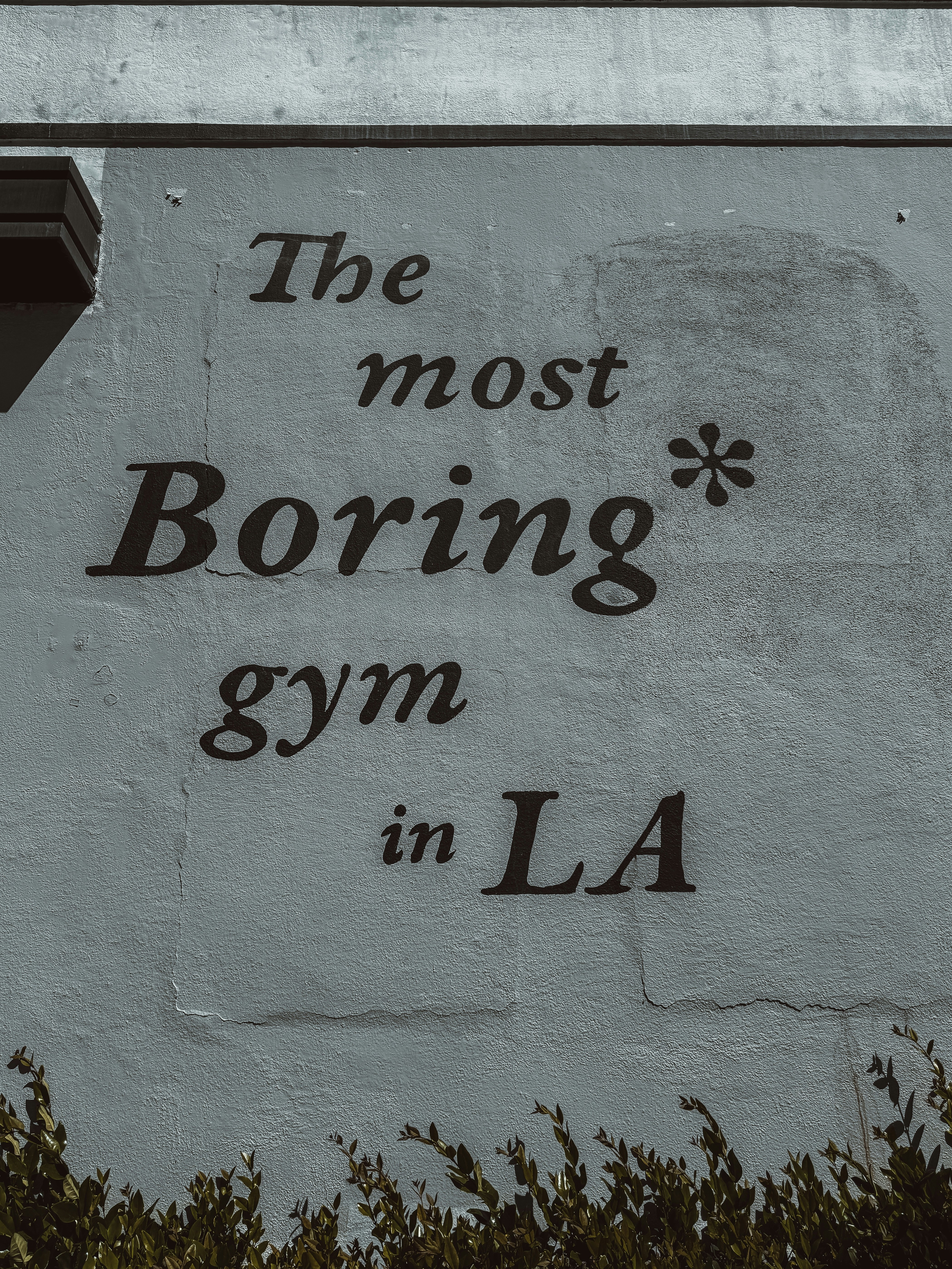 A sign on the side of a building that says the most boring gym in la ...