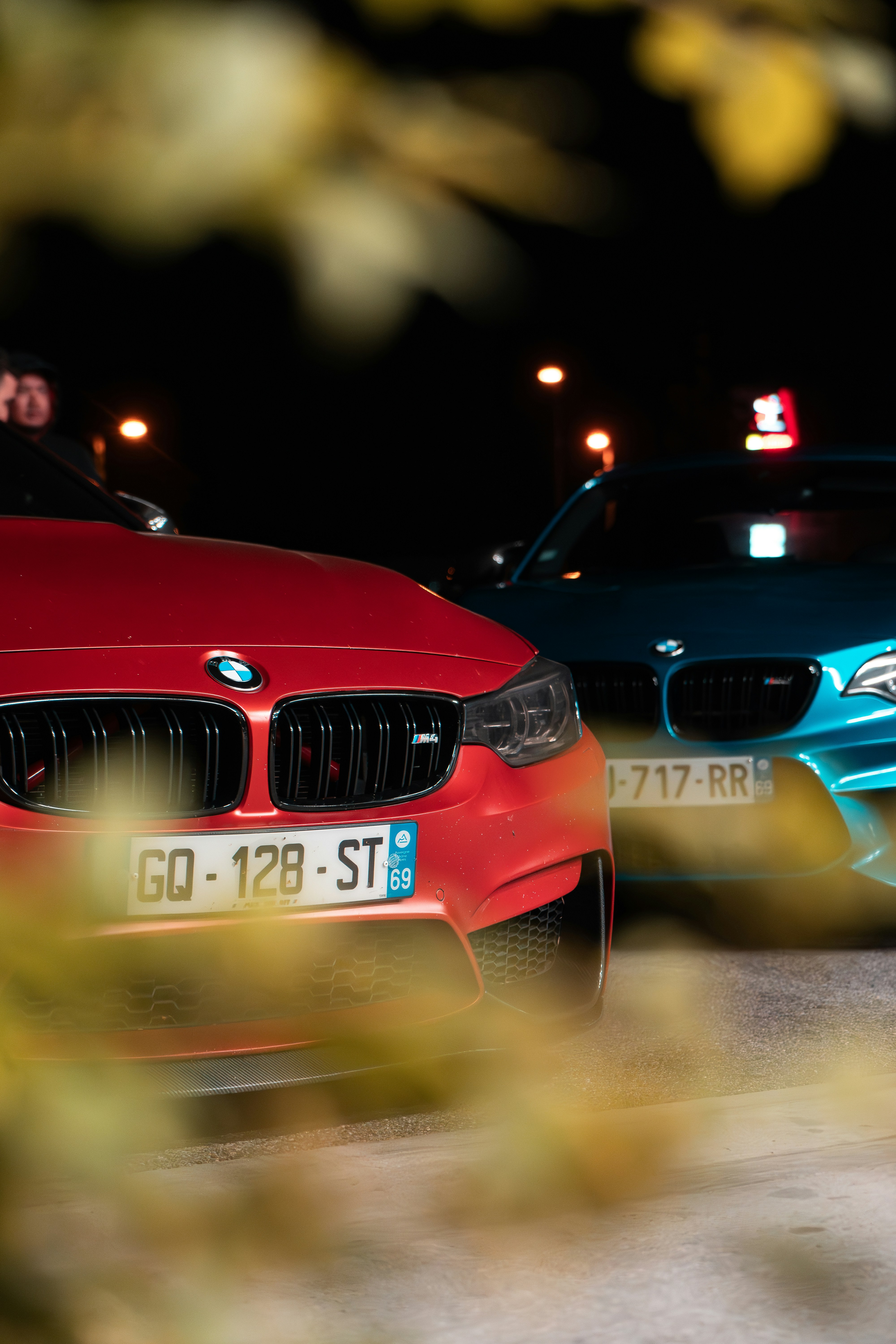 Red Front, Velvet Night: BMW Grille Emerging Through Soft Bokeh