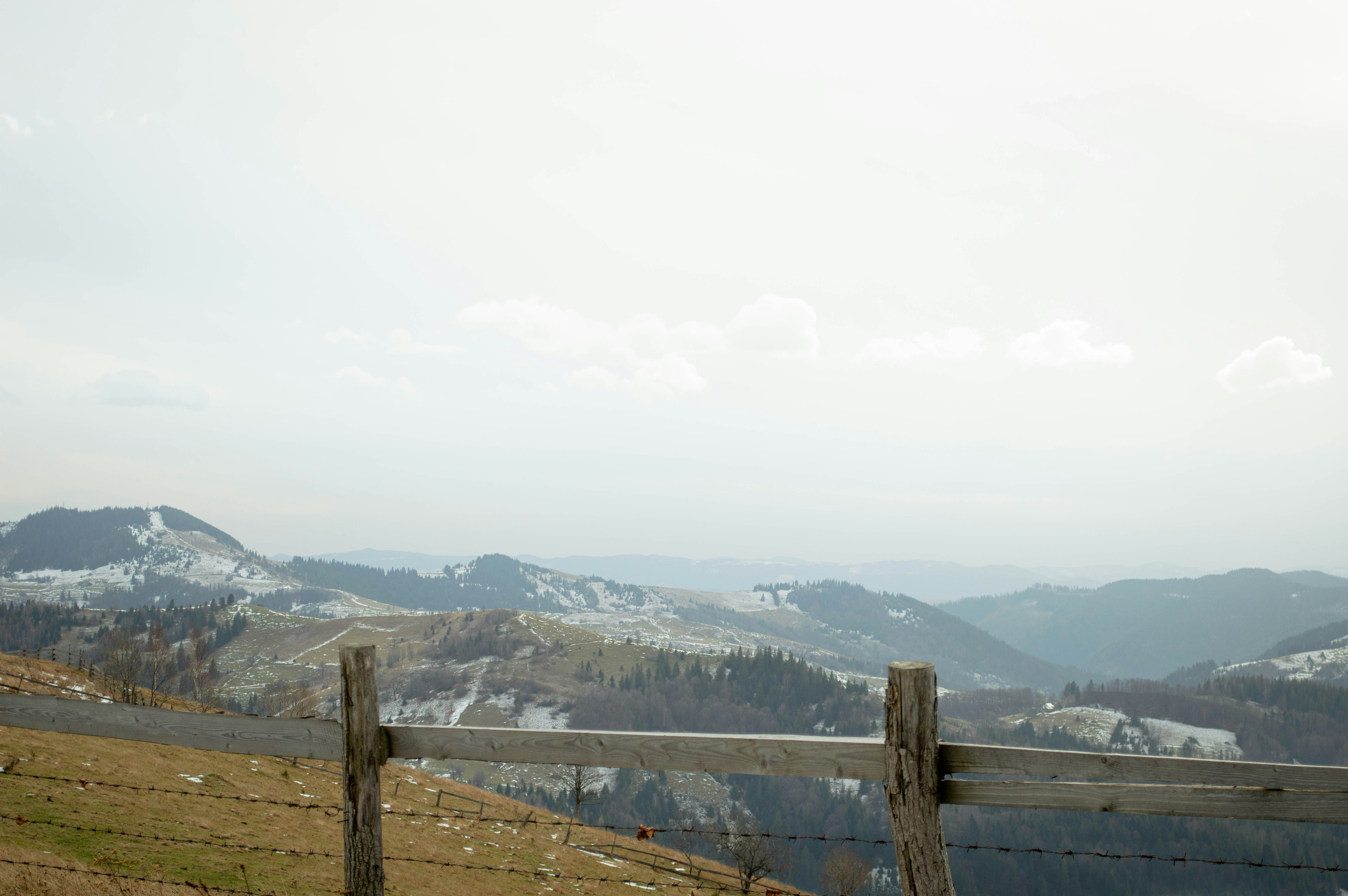 Weathered Rails, Snow-Dusted Valleys: A Quiet Alpine Vista