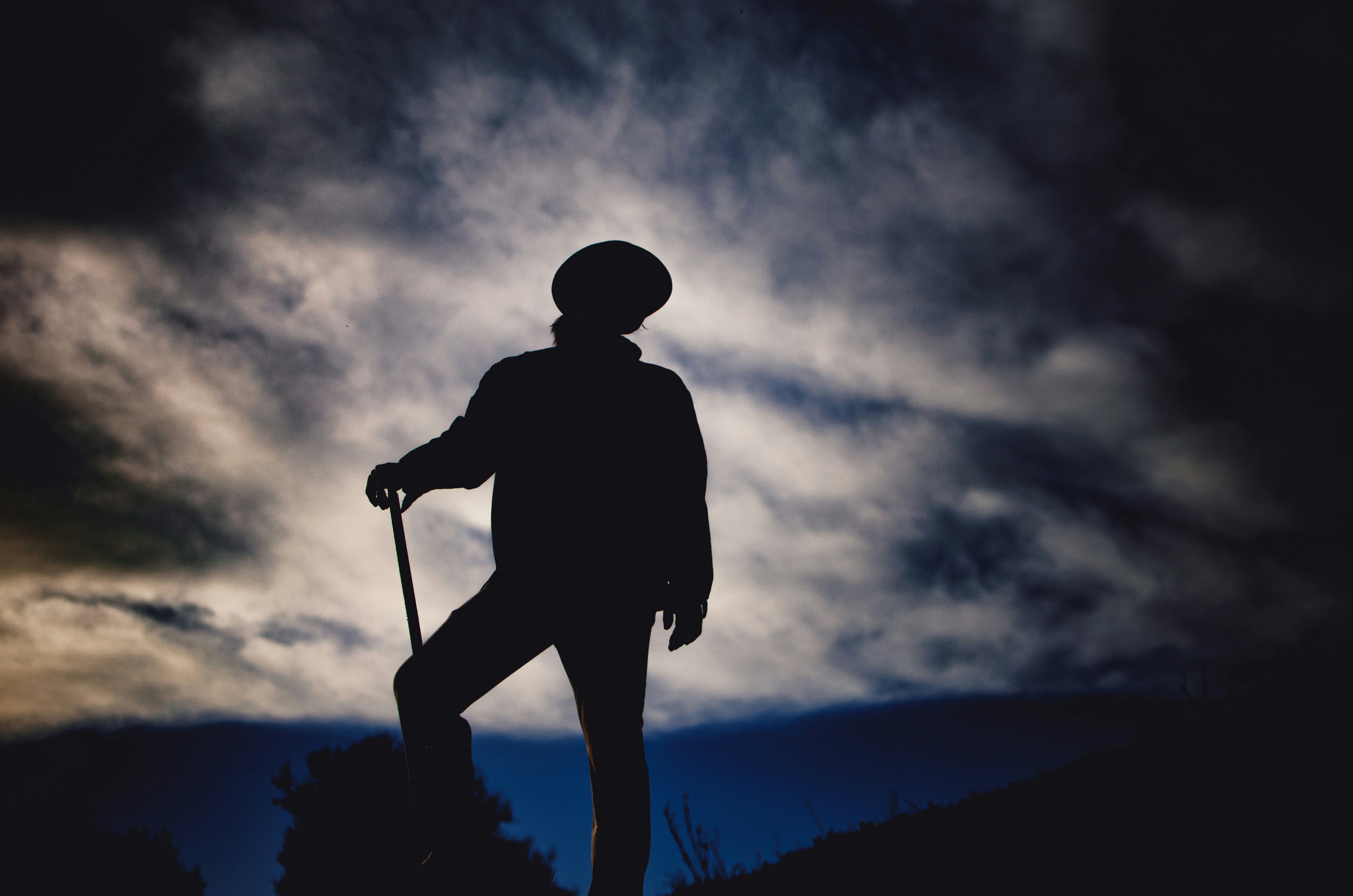 Lone Silhouette at Dusk on a Hillside