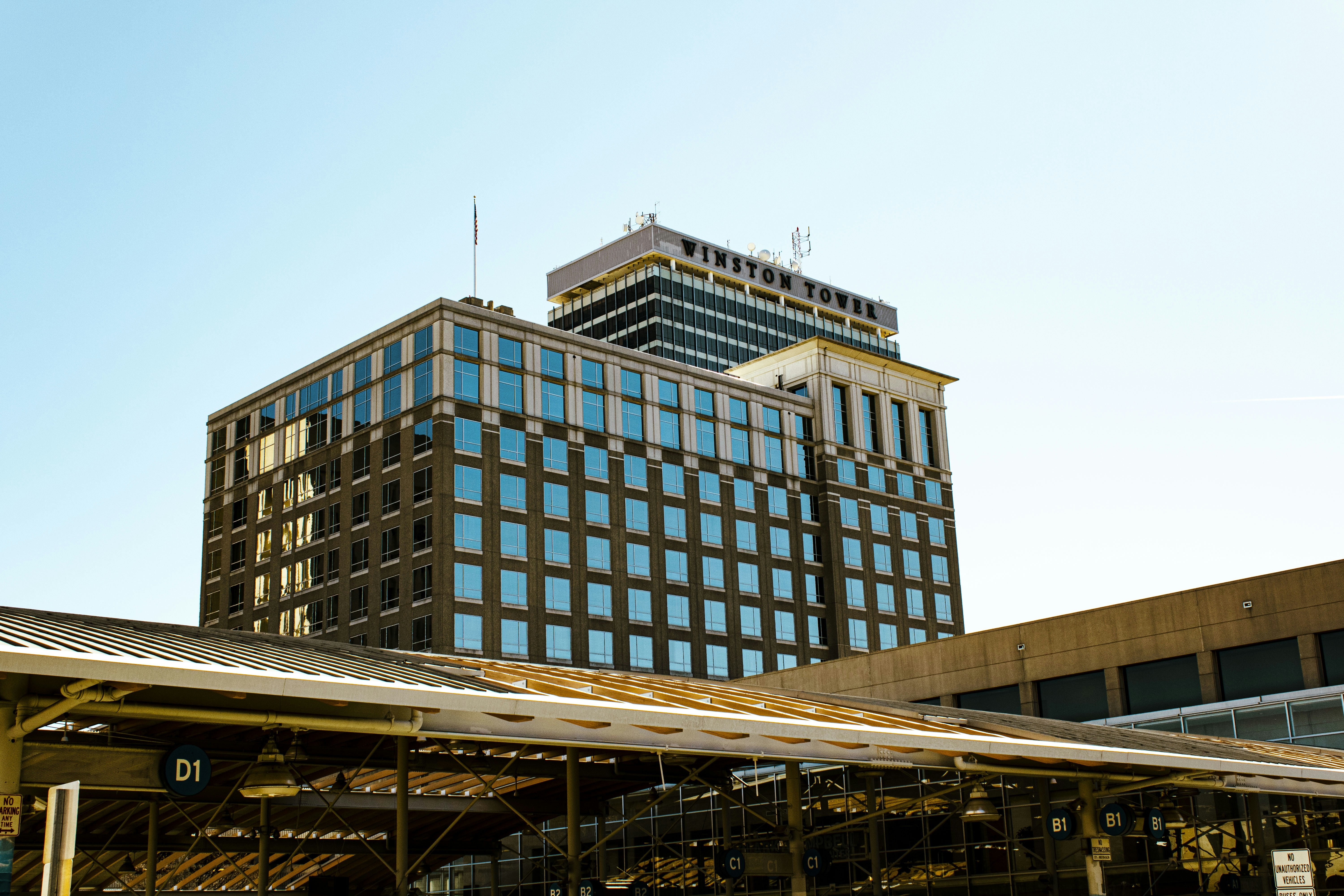 A large building with a lot of windows on top of it photo – Free ...